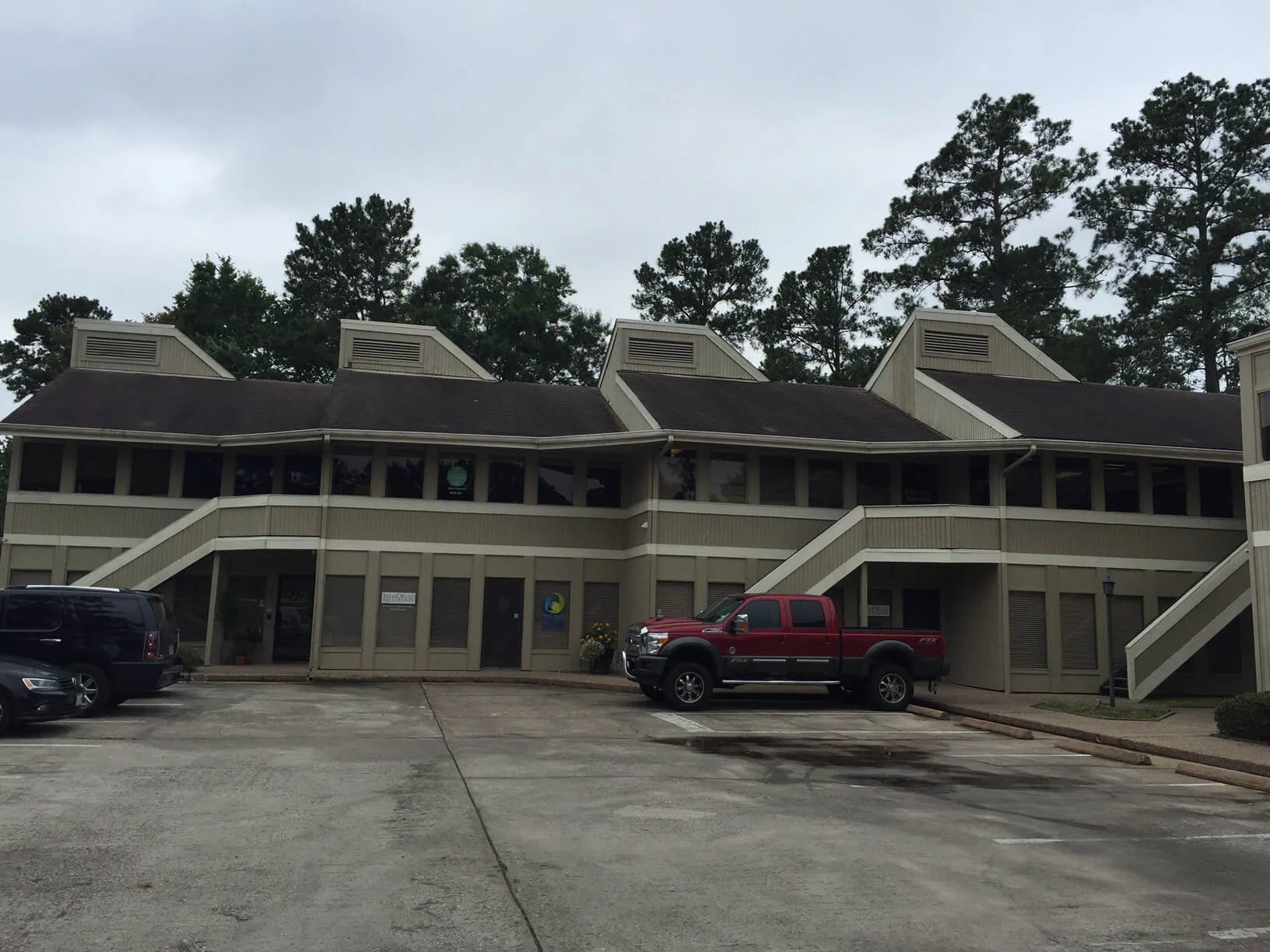An Office Building's Dated Exterior Colors Are Reborn Into A Dark ...