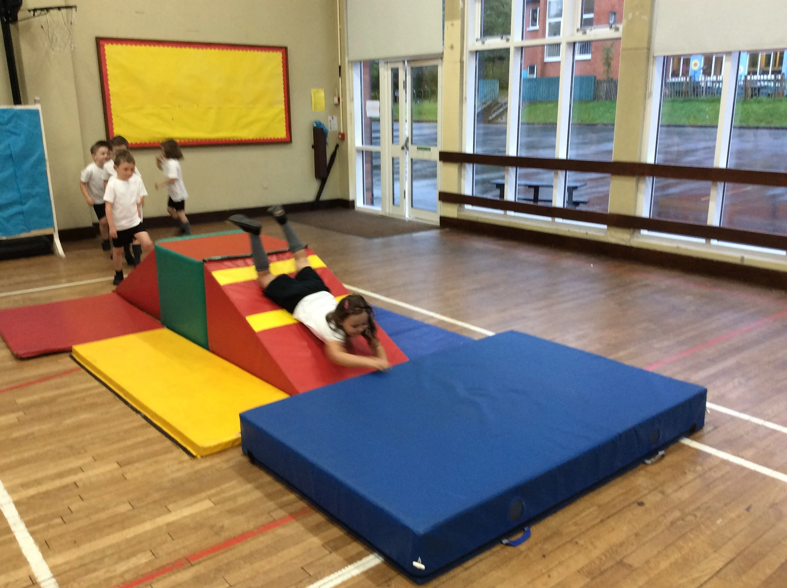 P2 are loving using the gymnastics equipment! — Holywood Primary School