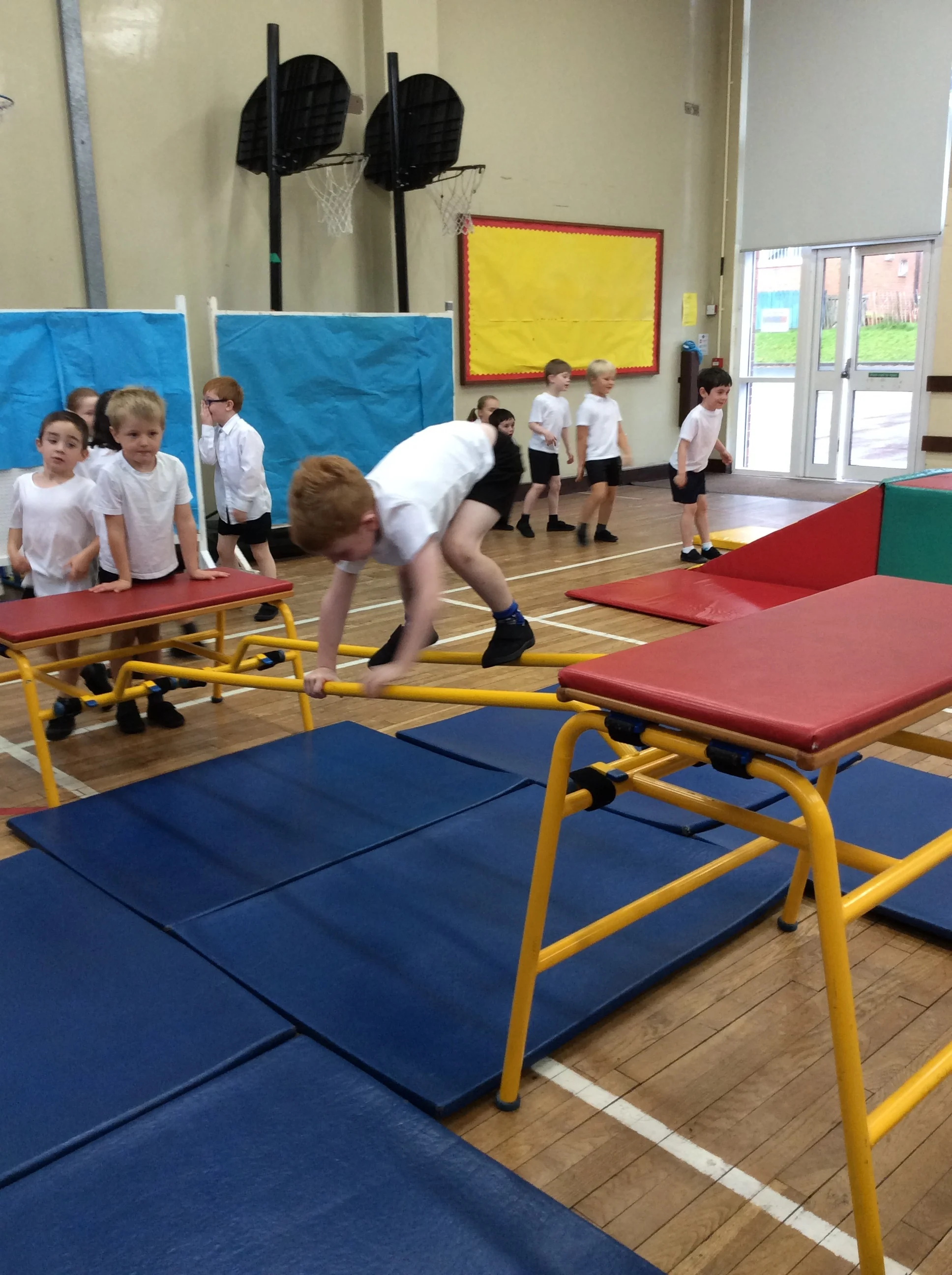 P2 are loving using the gymnastics equipment! — Holywood Primary School