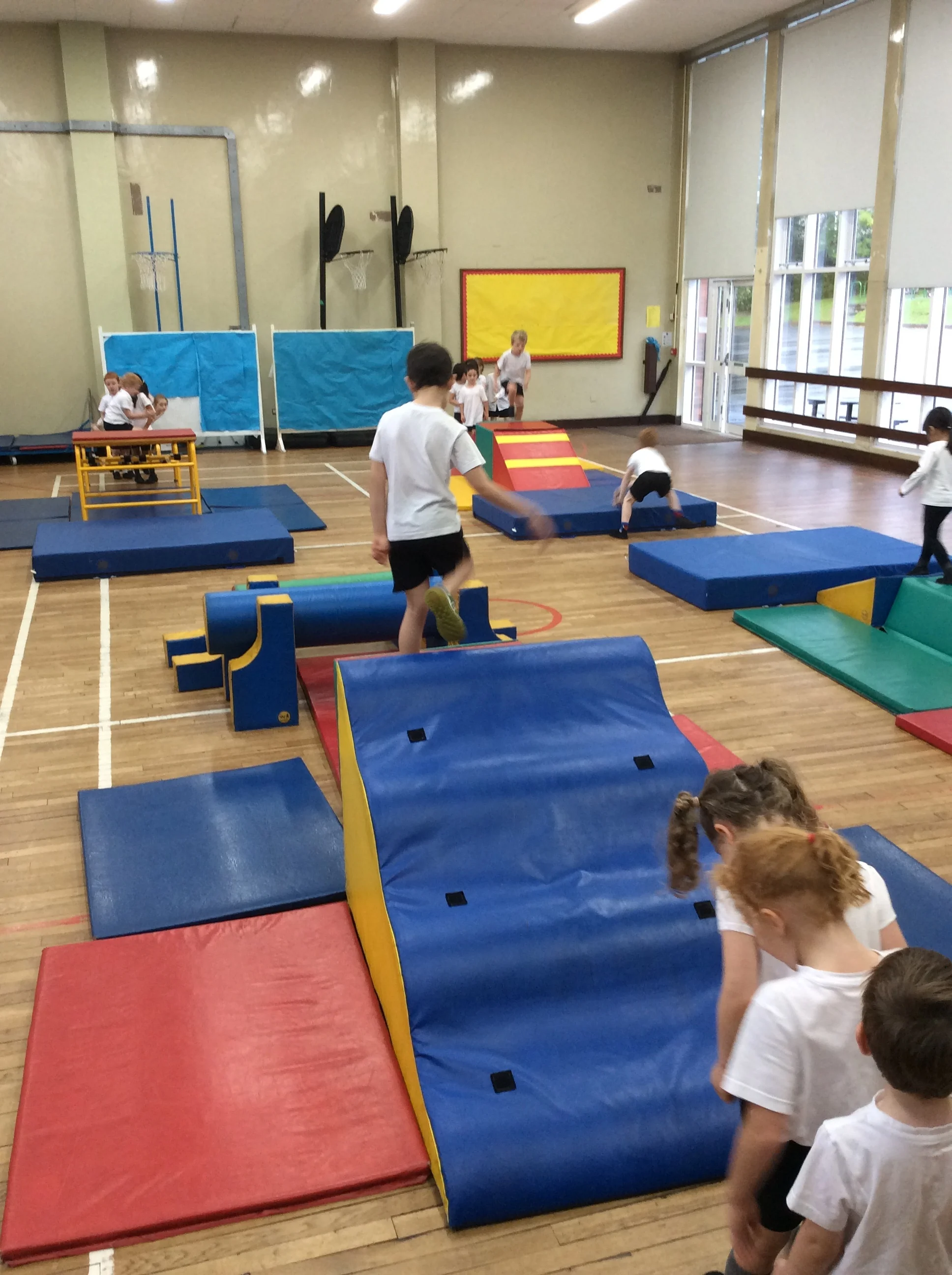 P2 are loving using the gymnastics equipment! — Holywood Primary School