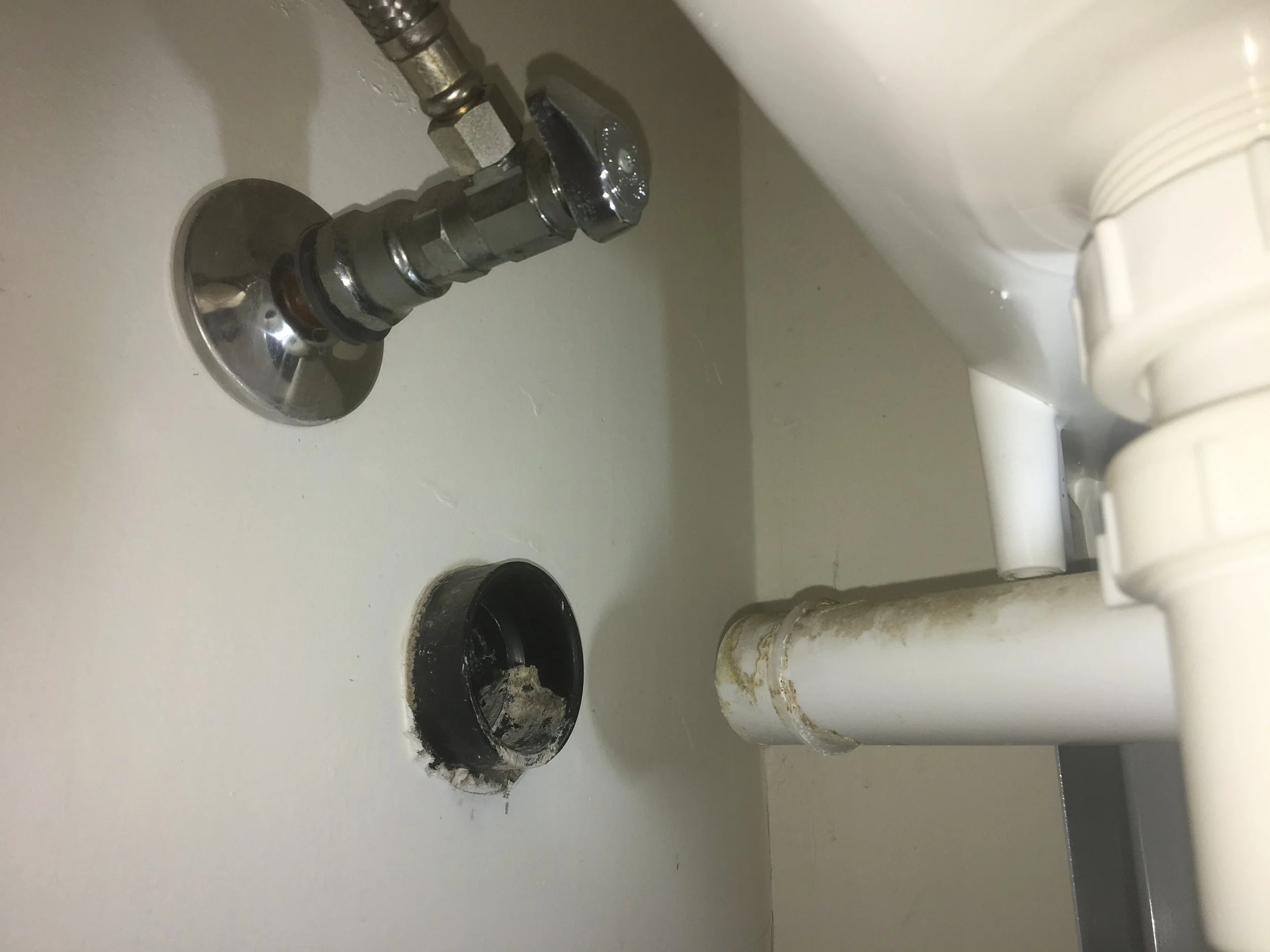 Missing sink drain fitting on the wall? (photo)