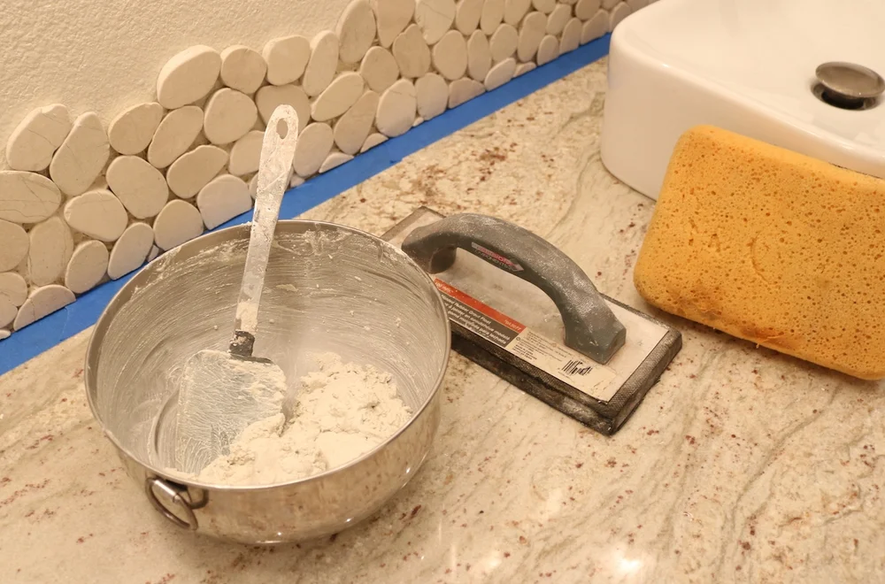 Grouting the live edge pebble tile backsplash.... — Beckwith's Treasures