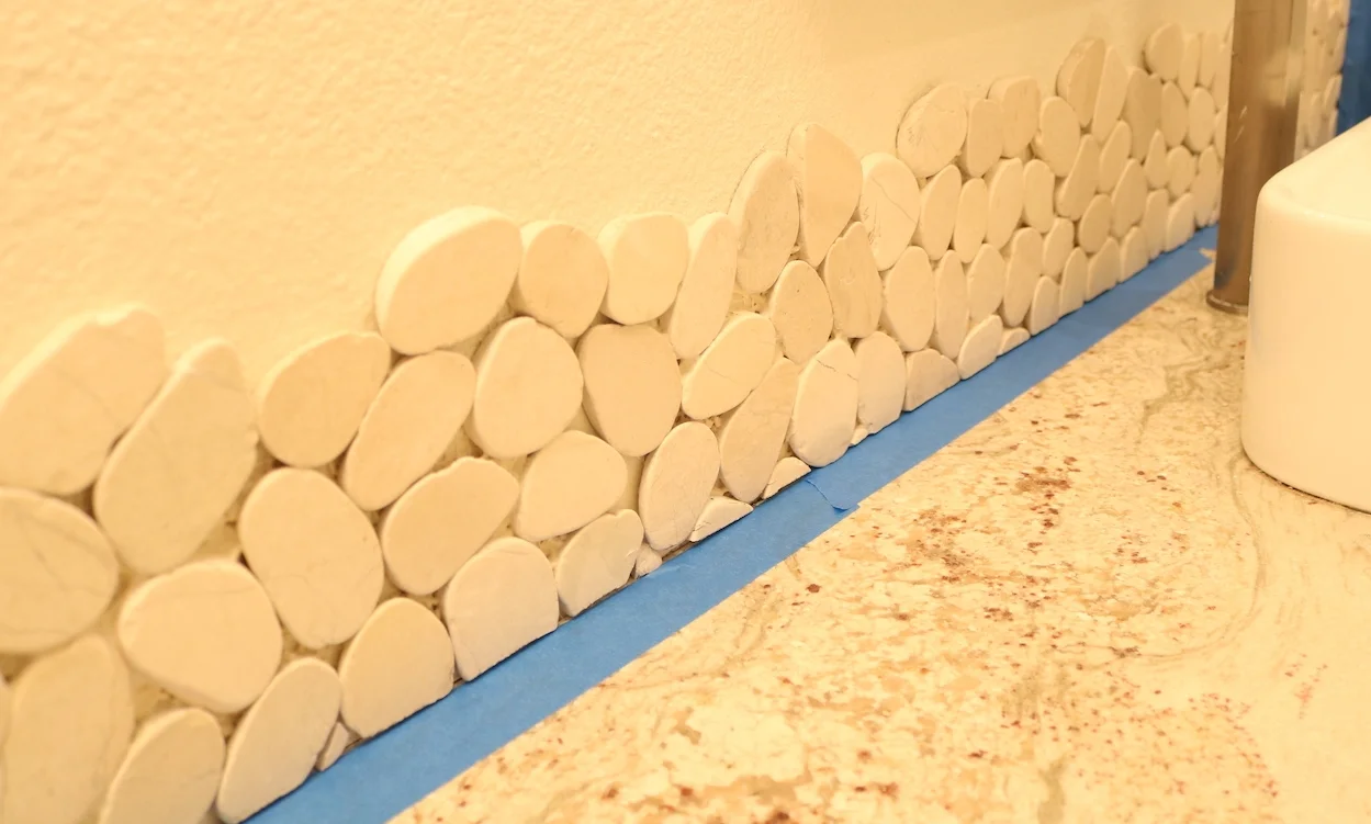 Grouting the live edge pebble tile backsplash.... — Beckwith's Treasures