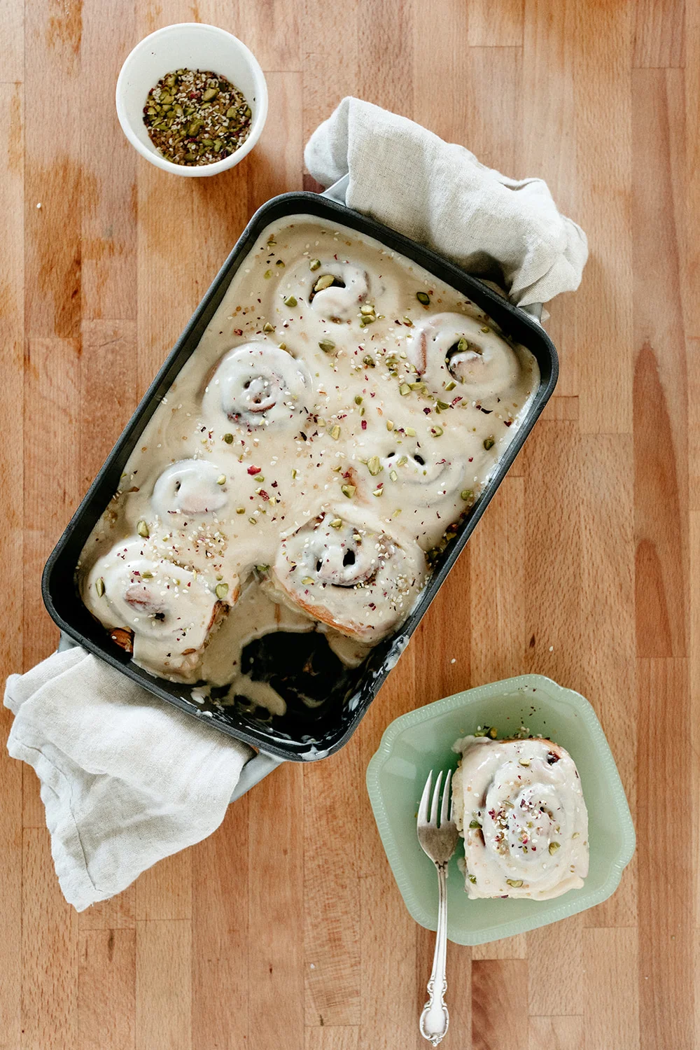 overnight cinnamon rolls with tahini cream frosting and pistachio rose ...