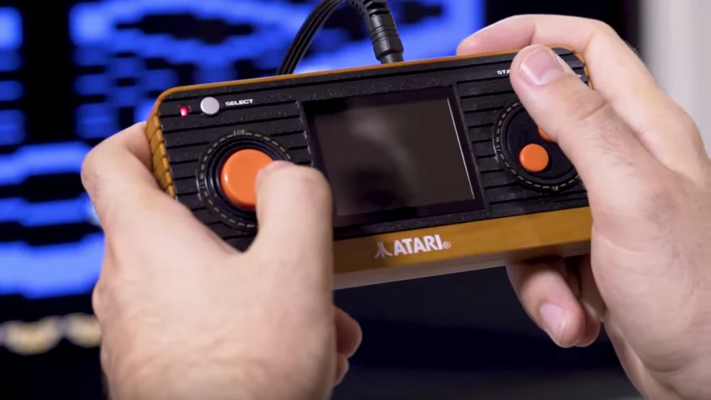 Atari Reveals Their Retro Wood Veneered Portable 2600 with a Promo ...