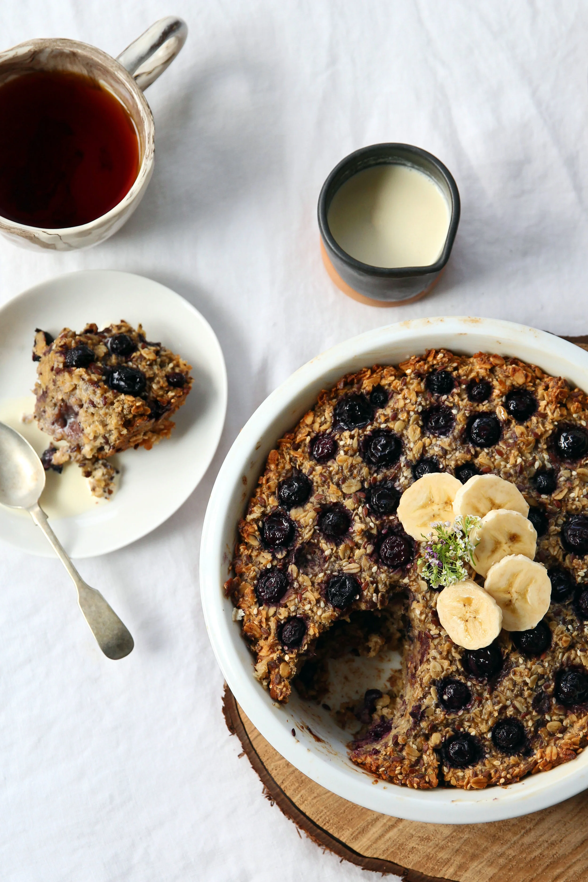 Baked banana oatmeal w/ wholesome seeds and blueberries — kelly gibney