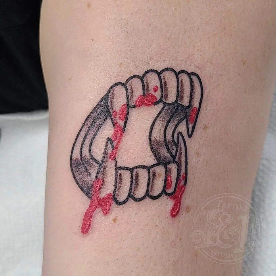 Plastic Vampire Teeth Tattoo