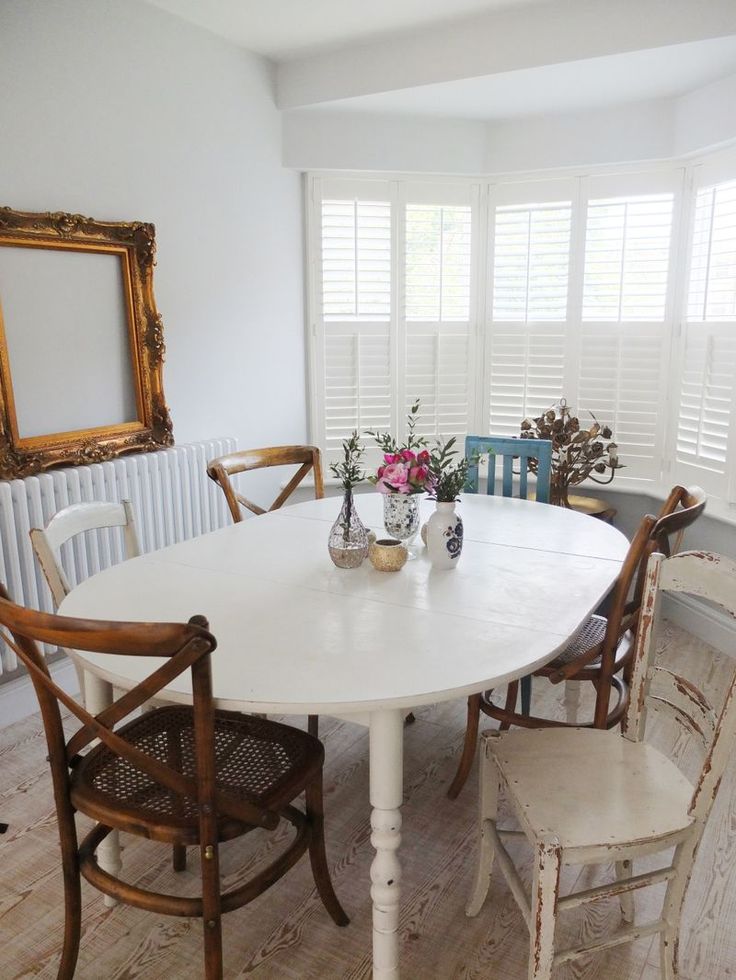 mismatched chairs around a dining table — toronto designers
