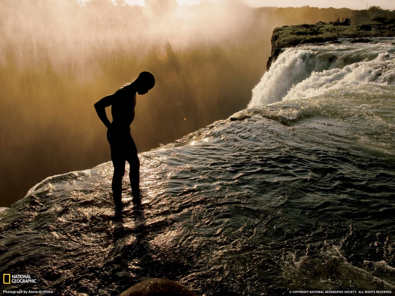 Annie Griffiths' Man Standing on Zambia's Victoria Falls Photo — Telos ...