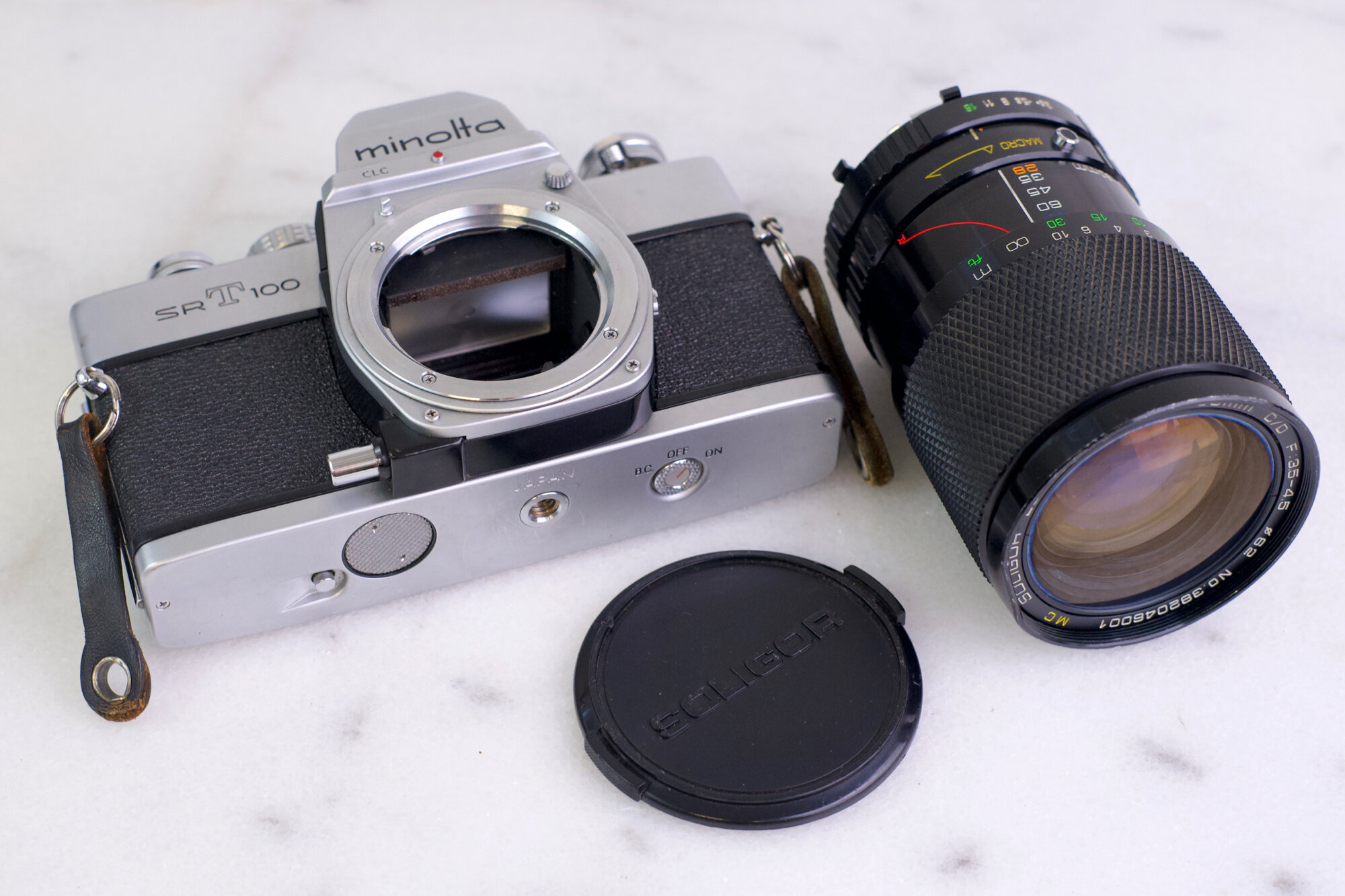 Minolta SRT 100 35mm Film Camera with 28-80mm Zoom Lens, Lens Cap and ...