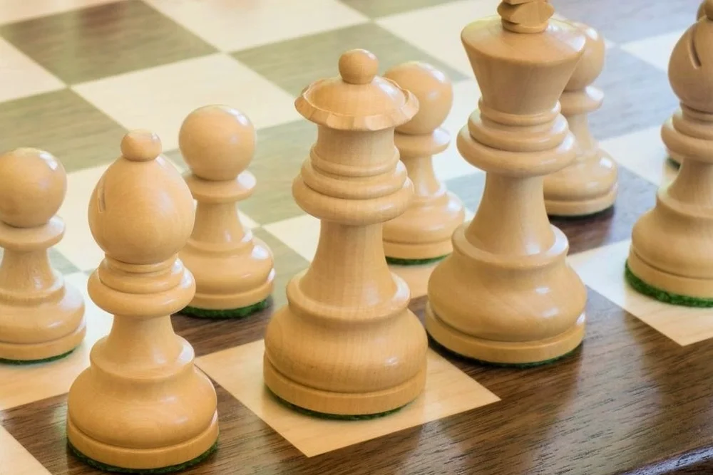 Carved wooden chess board with wooden chess pieces — Three Trees ...