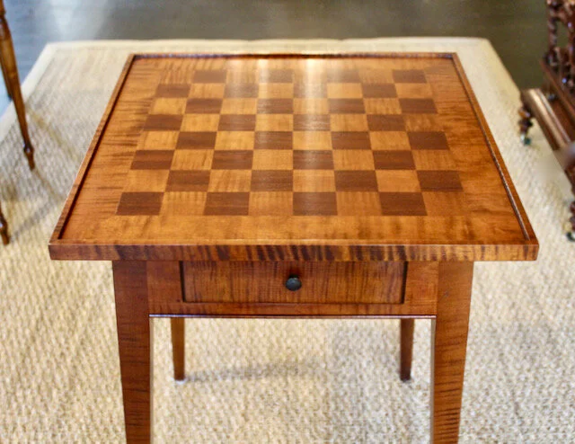 One drawer game table with tapered legs in tiger maple, inlaid chess ...