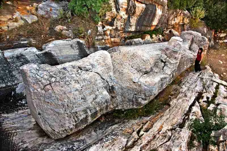 The Apollo Kouros: A Colossal Ancient Statue Resting on a Hillside in ...