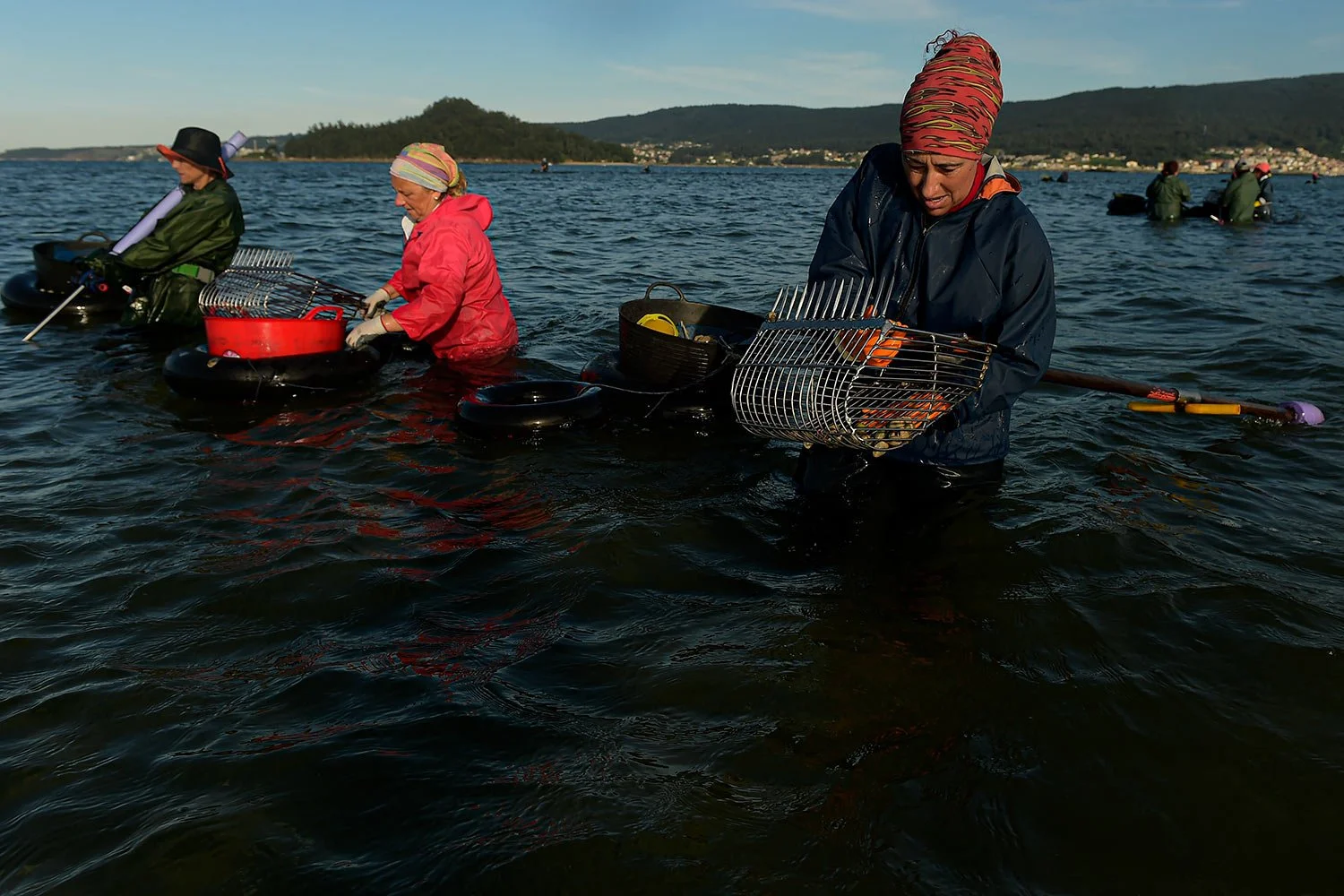 As Spain's 'peasant farmers of the sea,' groups of women dig for clams ...