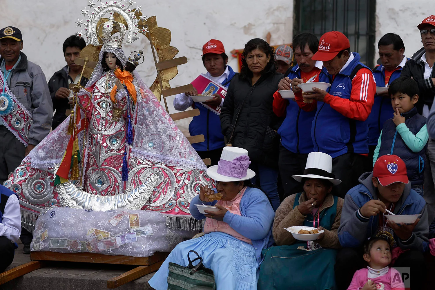 Veneration of Bolivia's patron saint spreads to Peru — AP Photos