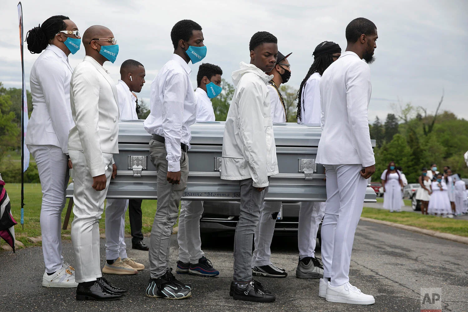 Funeral delayed: tiaras, white outfits, turquoise face masks — AP Photos