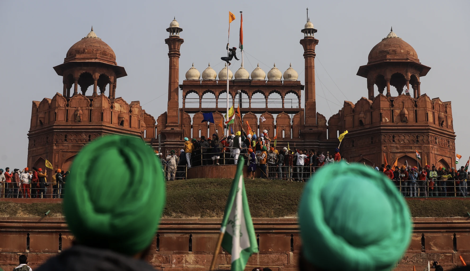 Indian farmers stormed the capital’s fort to fly a Sikh flag