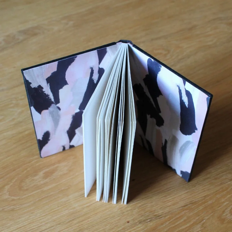 a small trio with print endpapers — paperiaarre