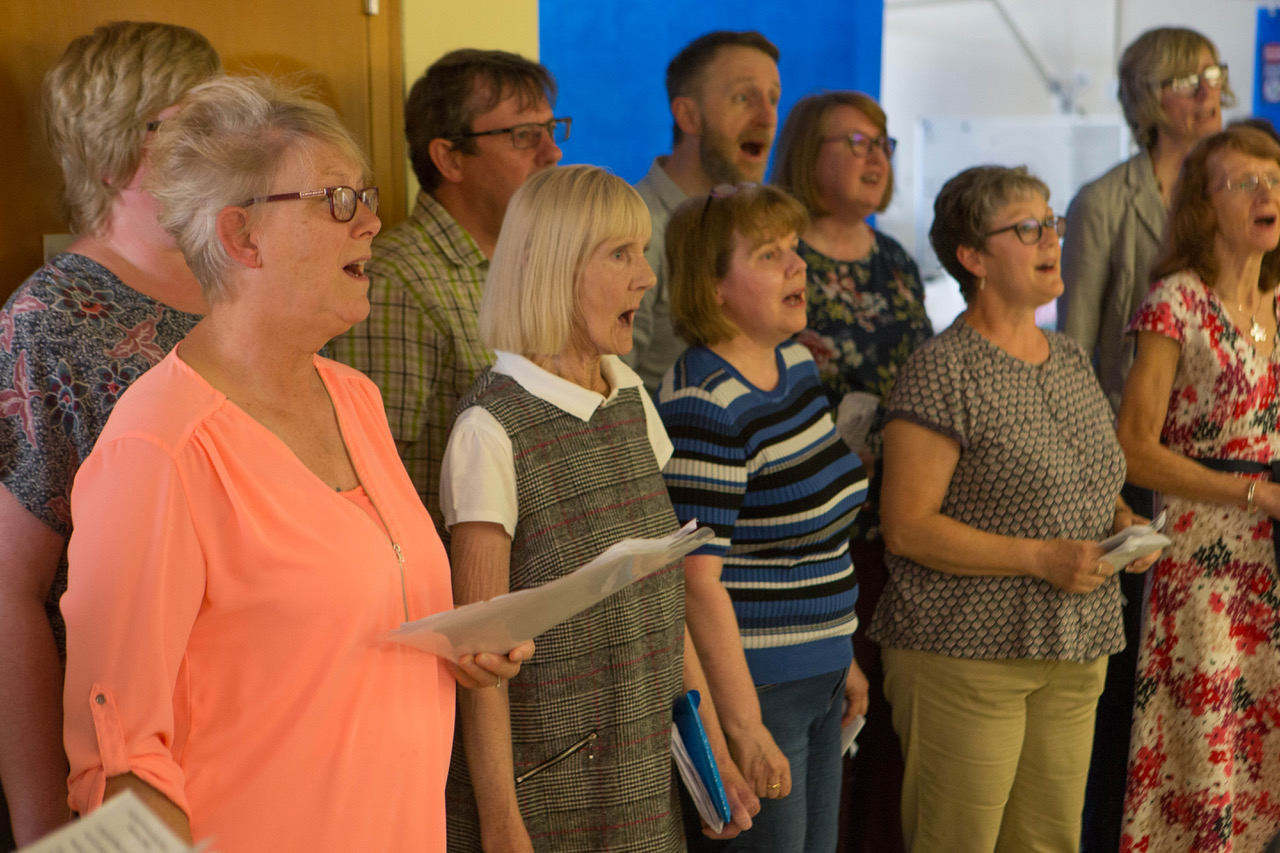 About Us — as one community choir