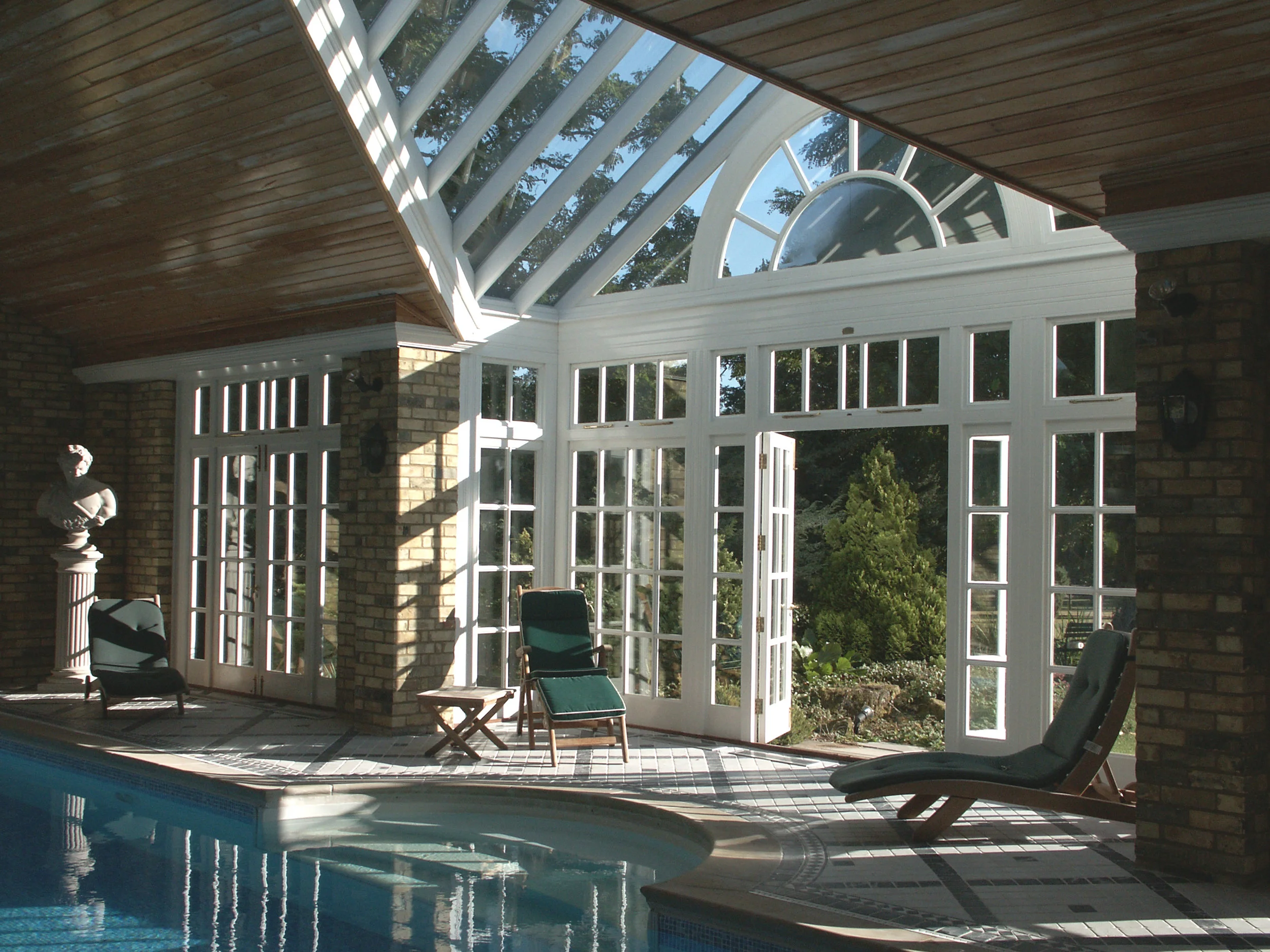 Indoor pool with conservatory entrance — Town & Country Conservatories
