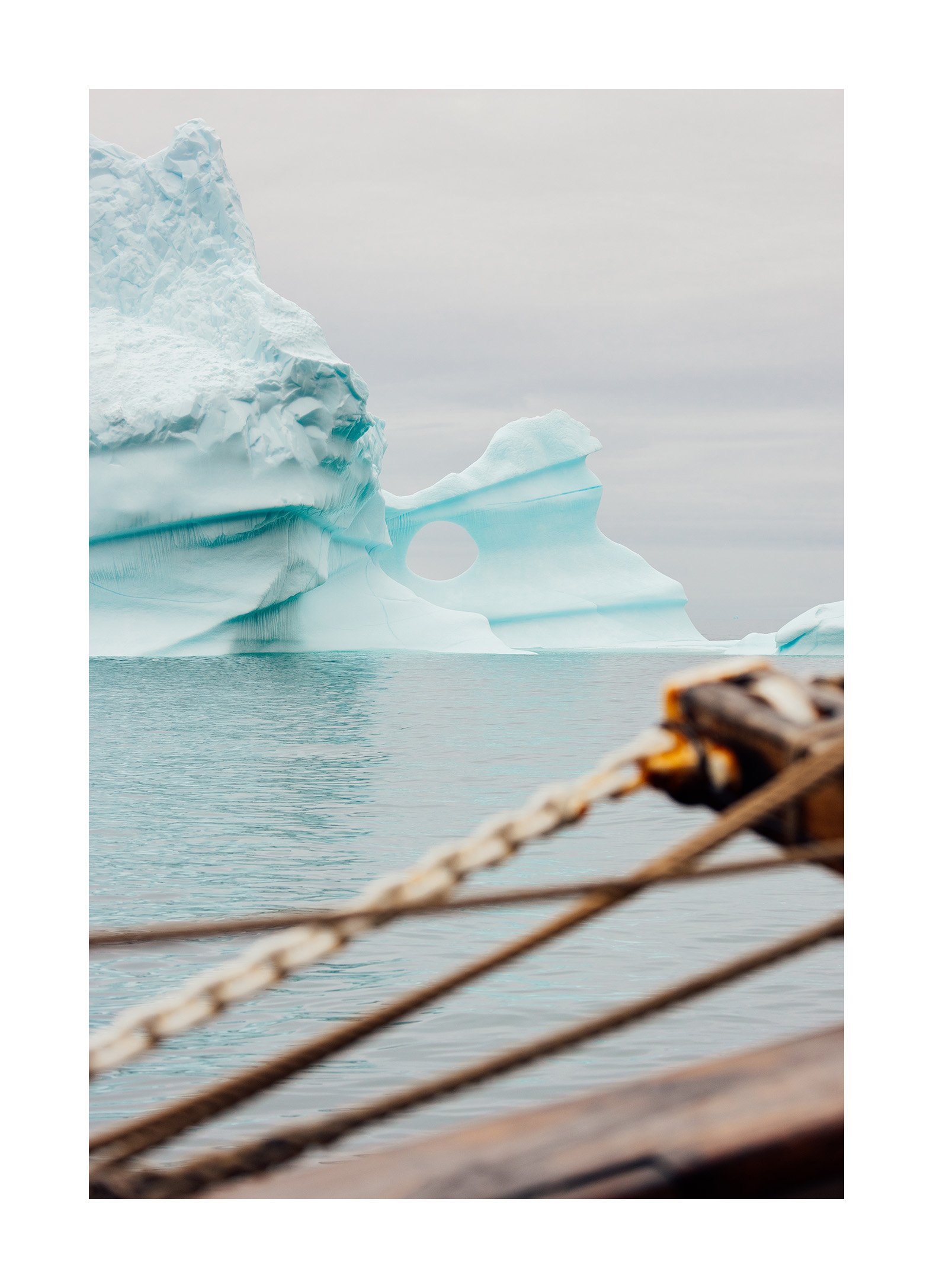 Frozen Majesty Framed: A Ship Porthole View of an Arctic Iceberg — The ...