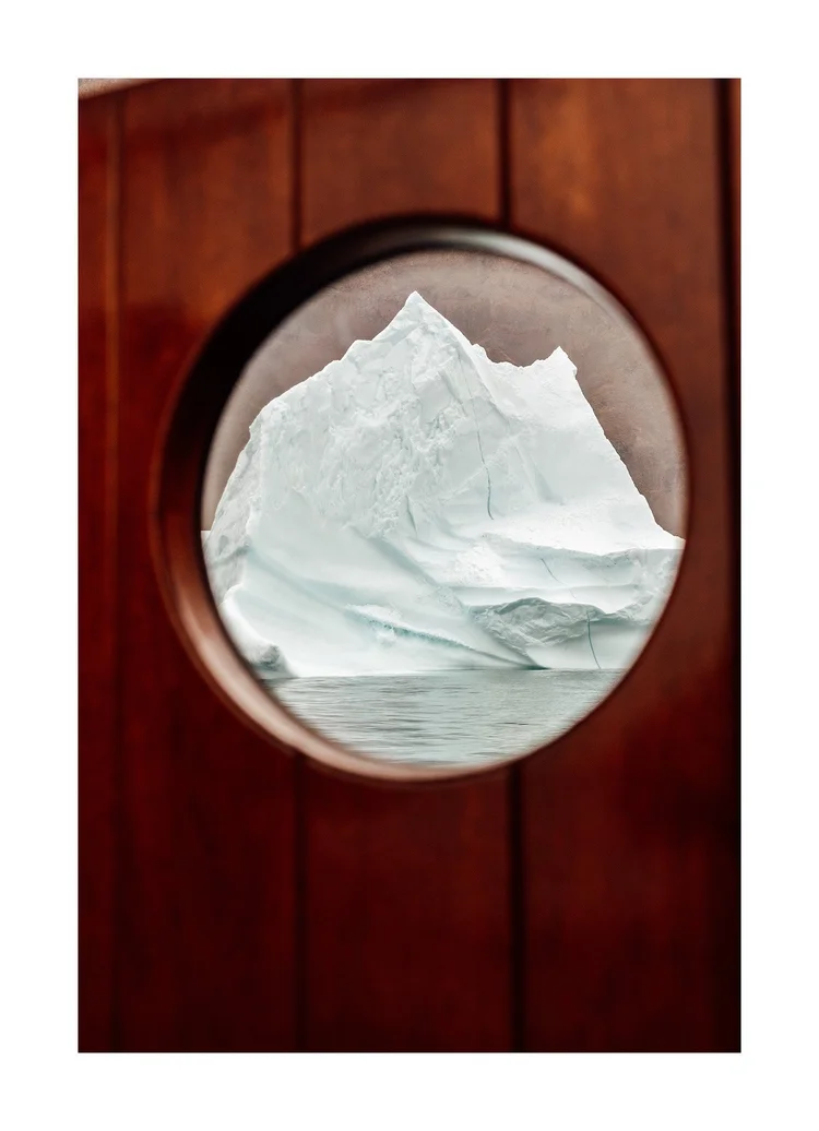 Frozen Majesty Framed: A Ship Porthole View of an Arctic Iceberg — The ...