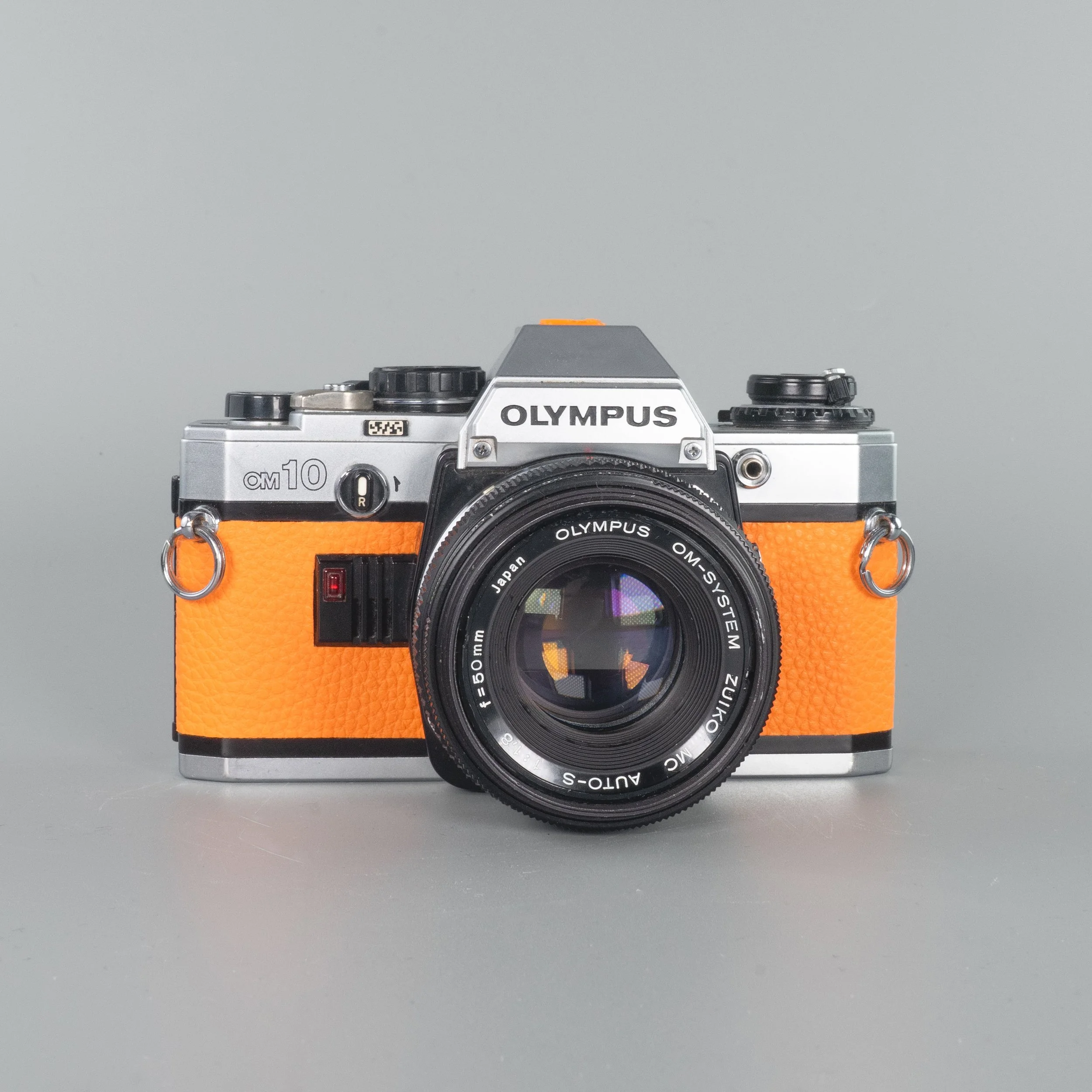 Olympus OM10 (Tangerine) - Refurbished 35mm SLR Film Camera — LensFayre