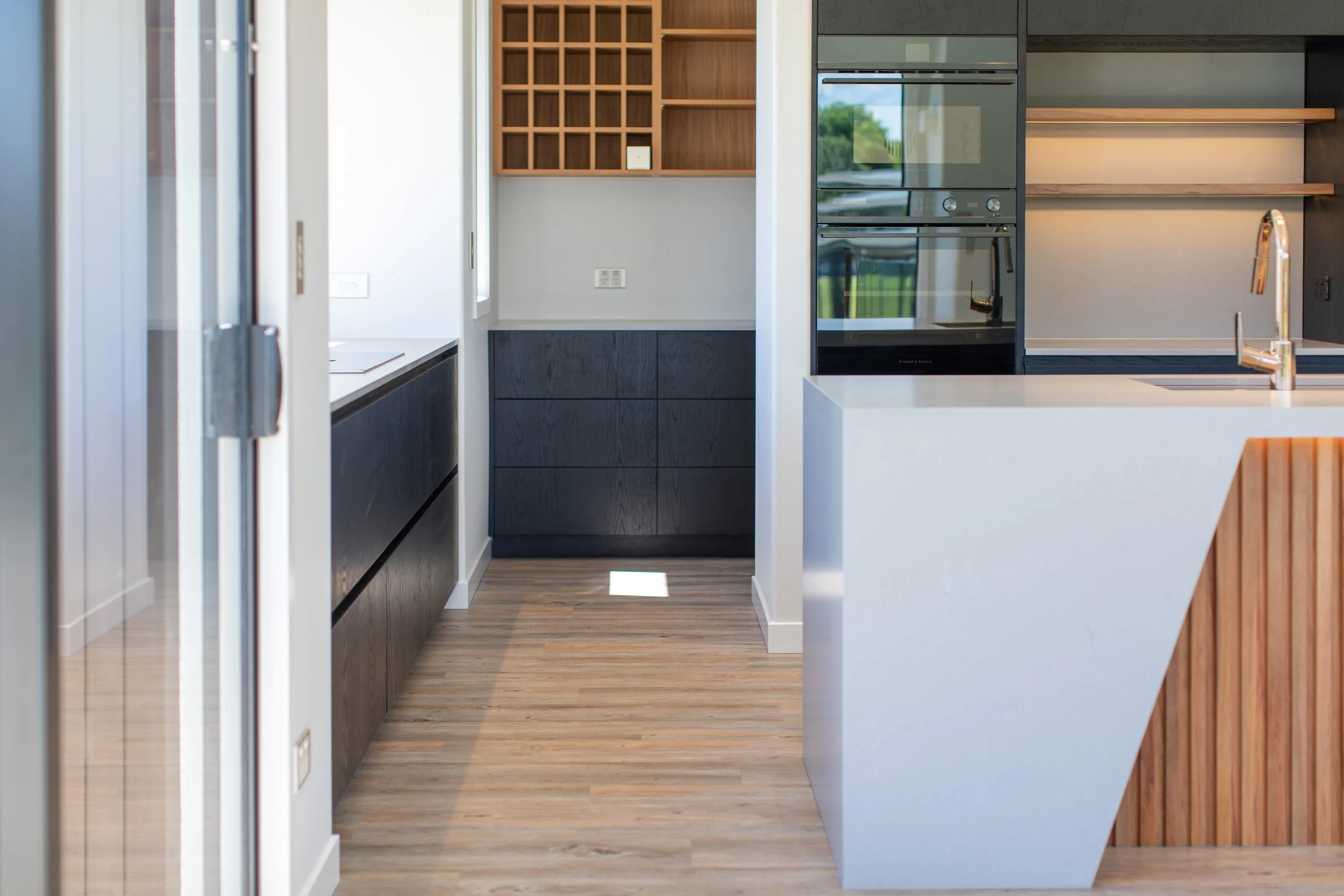 NZ Native Rimu battens and shelves complement this raw concrete ...