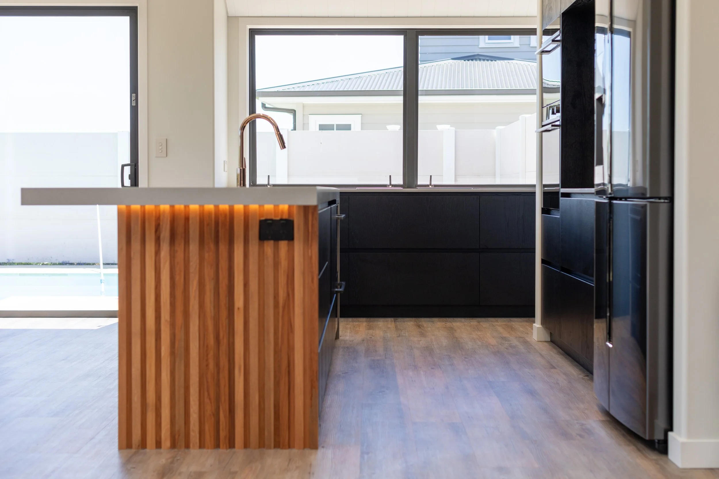 NZ Native Rimu battens and shelves complement this raw concrete ...