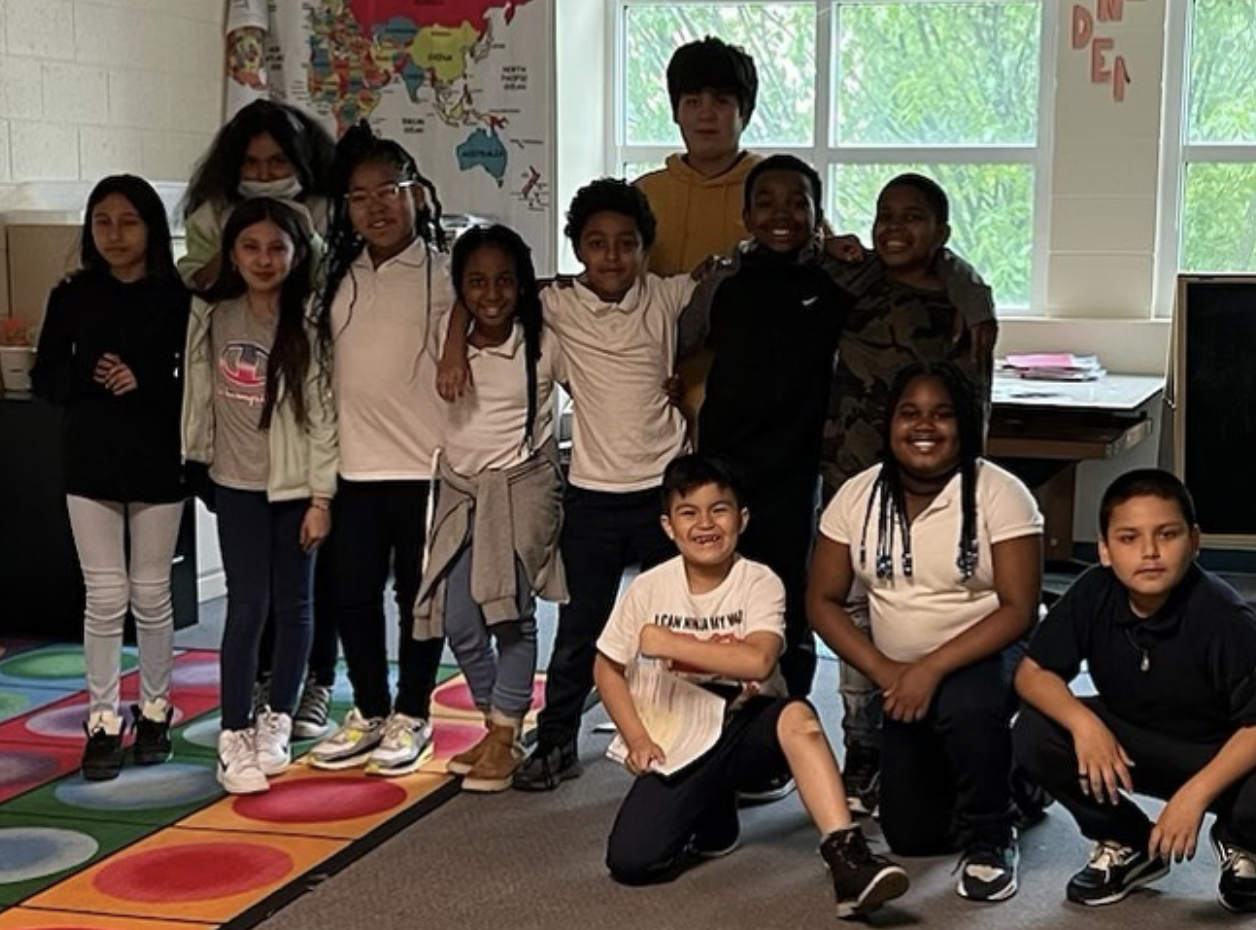 4th graders modeling the Barnard uniform of white and navy blue.