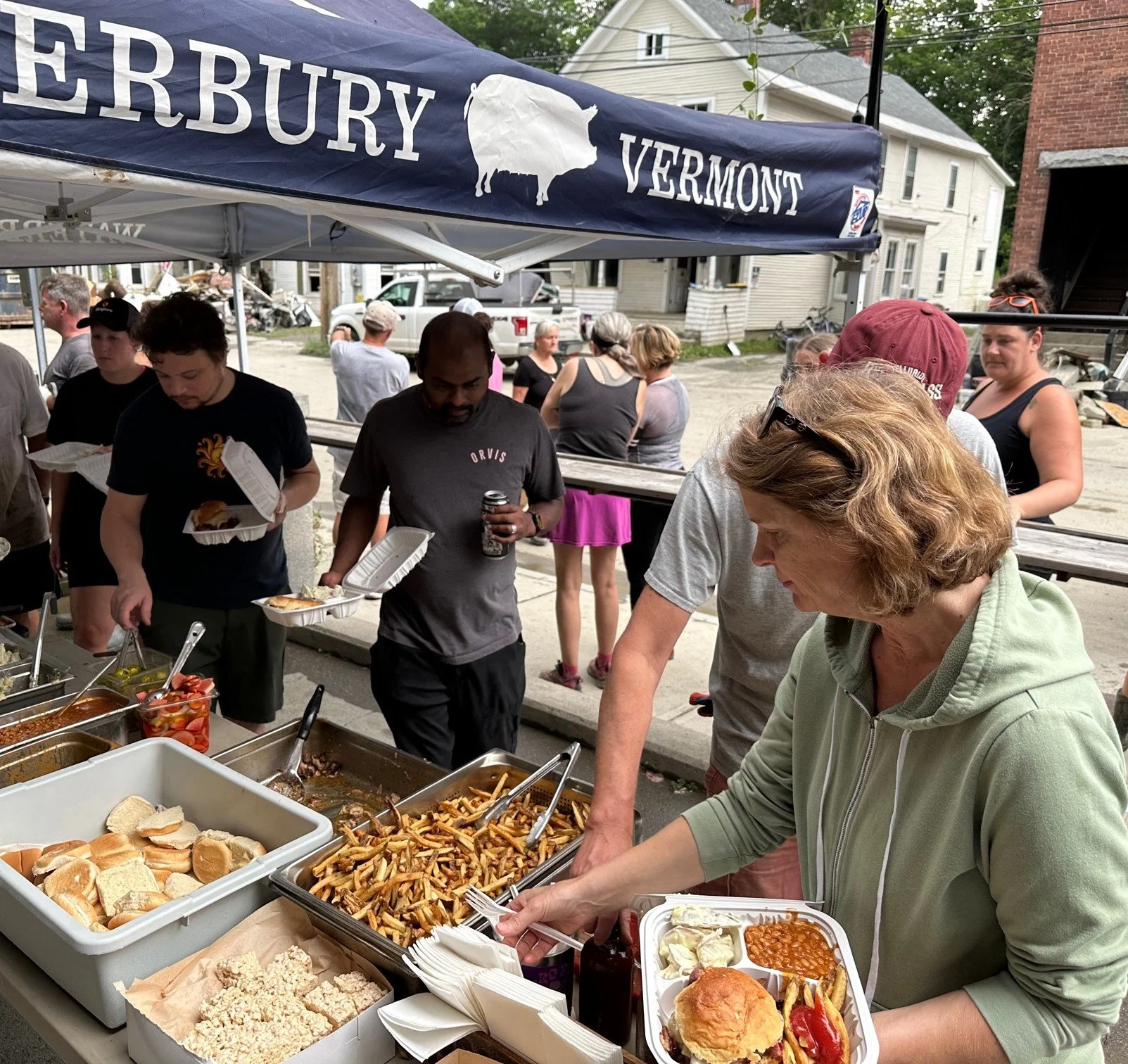 Welch tours flood zone amidst mud, cleanup, free lunch, socks, music ...