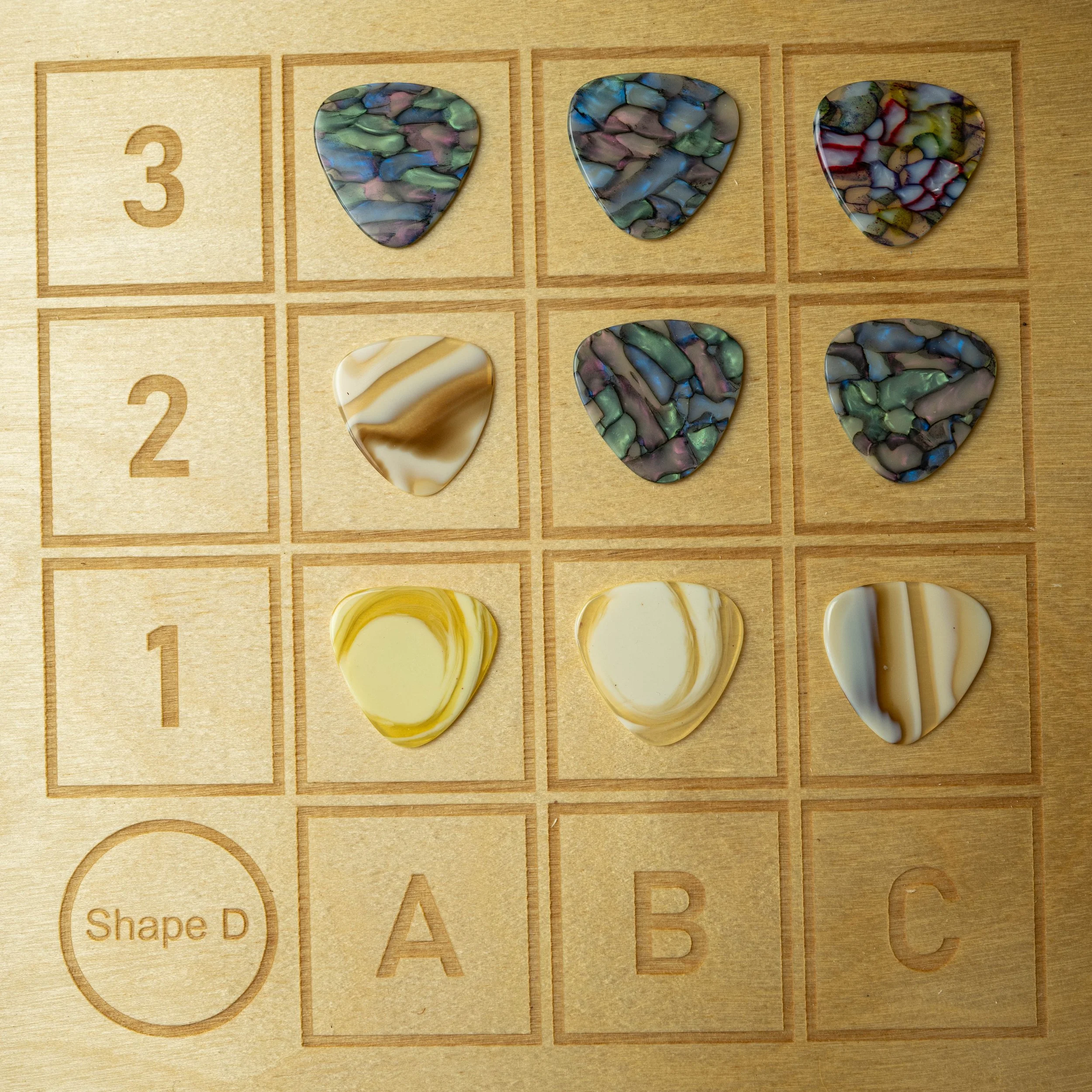 Shape D — Apollo Picks | Custom Made. Casein and PEEK.