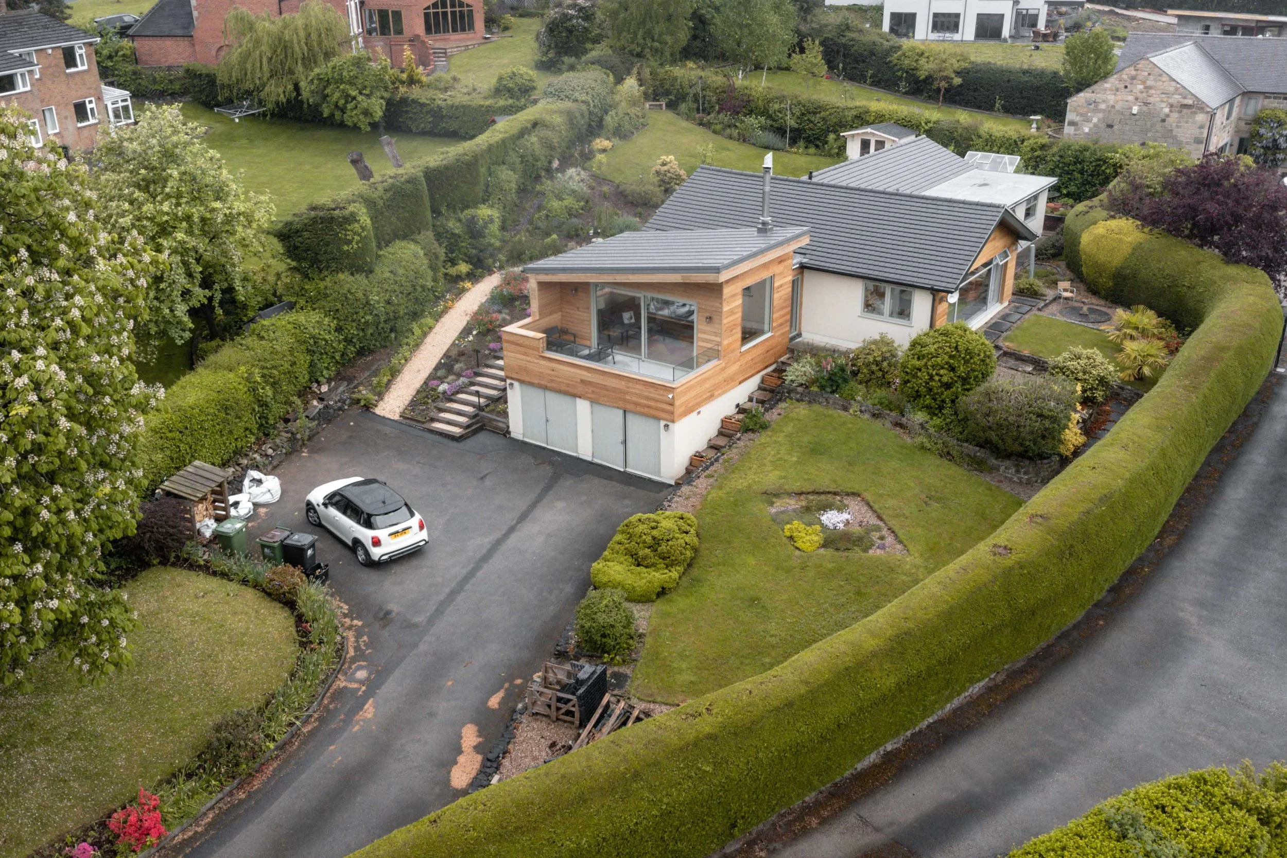 Timber claded monopitch front extension with balcony to Derbyshire ...