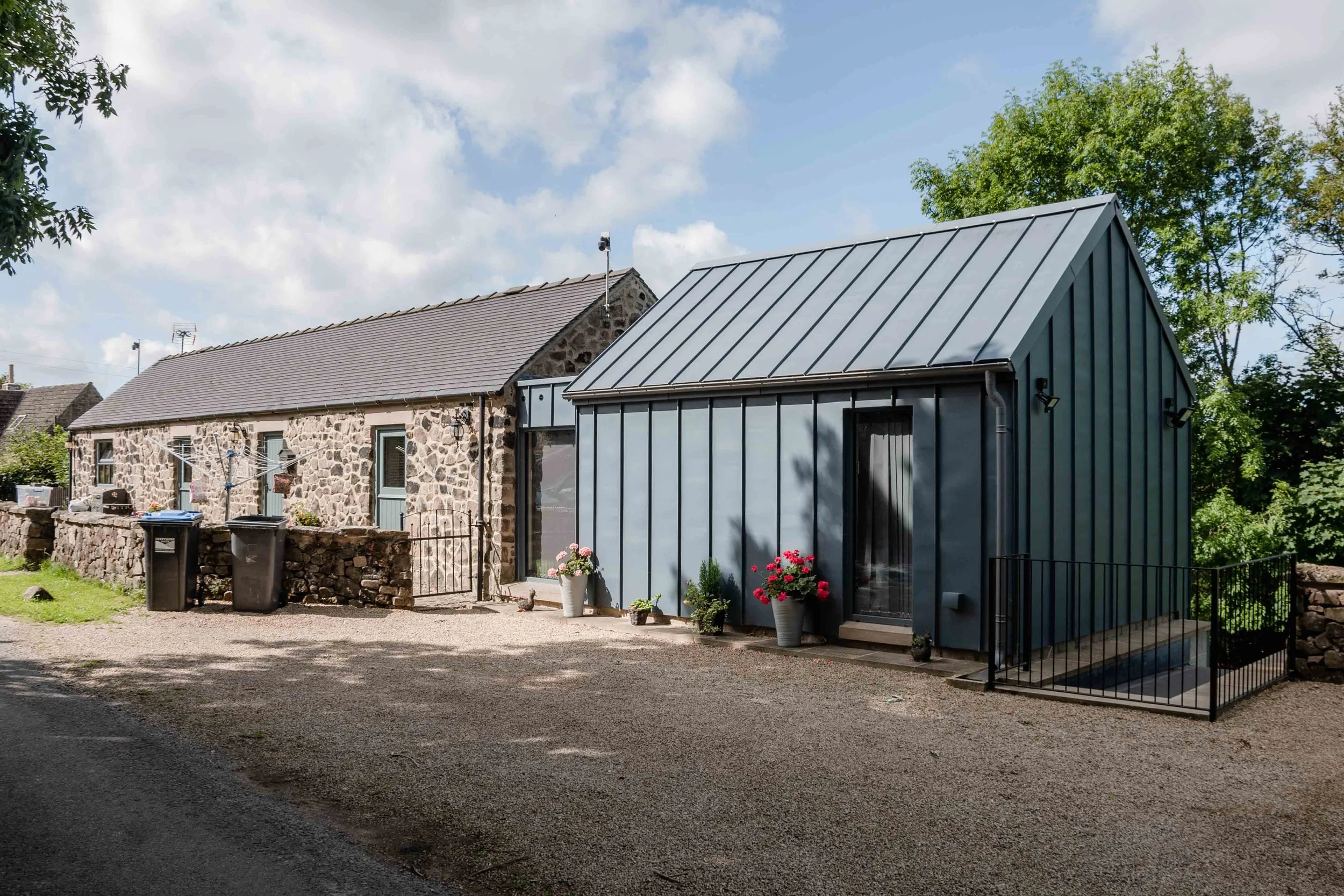 Contrasting zinc clad extension to historic agricultural barn with flat ...