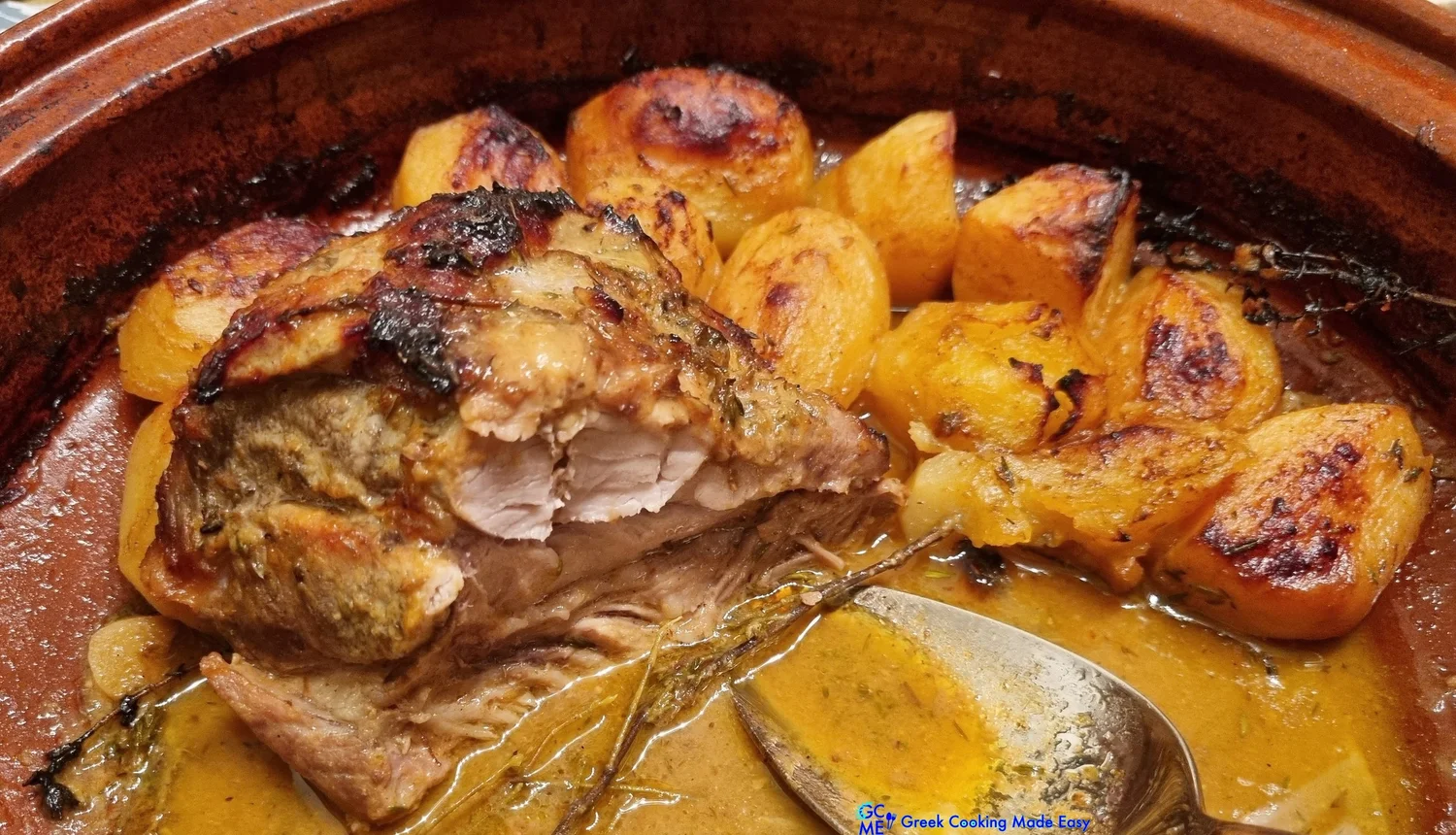 Greek Roasted Leg of Pork with Potatoes, Honey and Orange in a Clay pot ...
