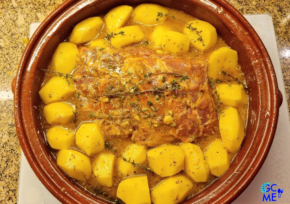Greek Roasted Leg of Pork with Potatoes, Honey and Orange in a Clay pot ...