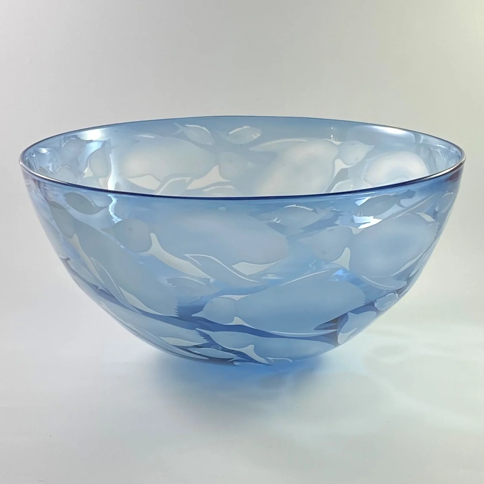 Steel blue crystal bowl decorated with penguins amongst fish by Julia ...