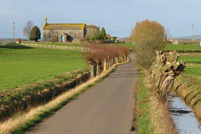 About & History — Godney Village