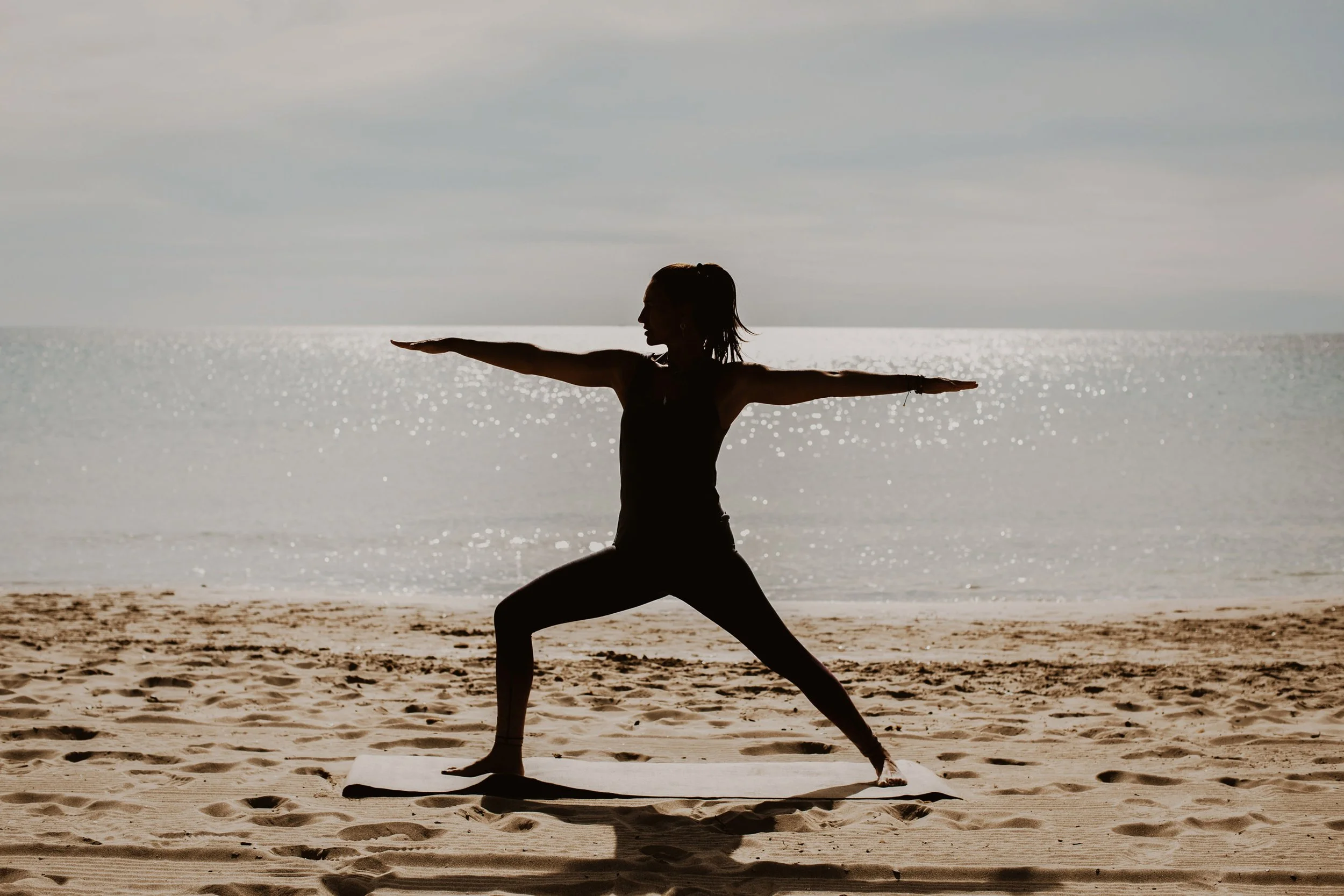 Couple Yoga On The Beach