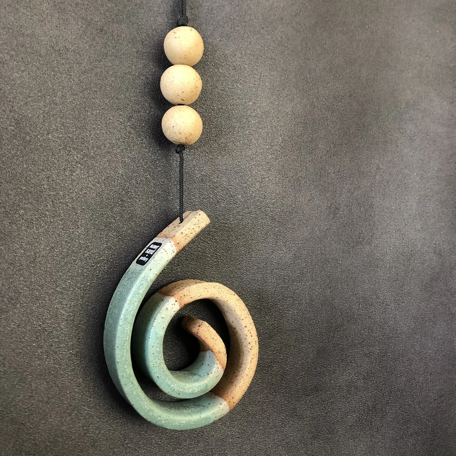 Koru Hanging — burnt sand pottery
