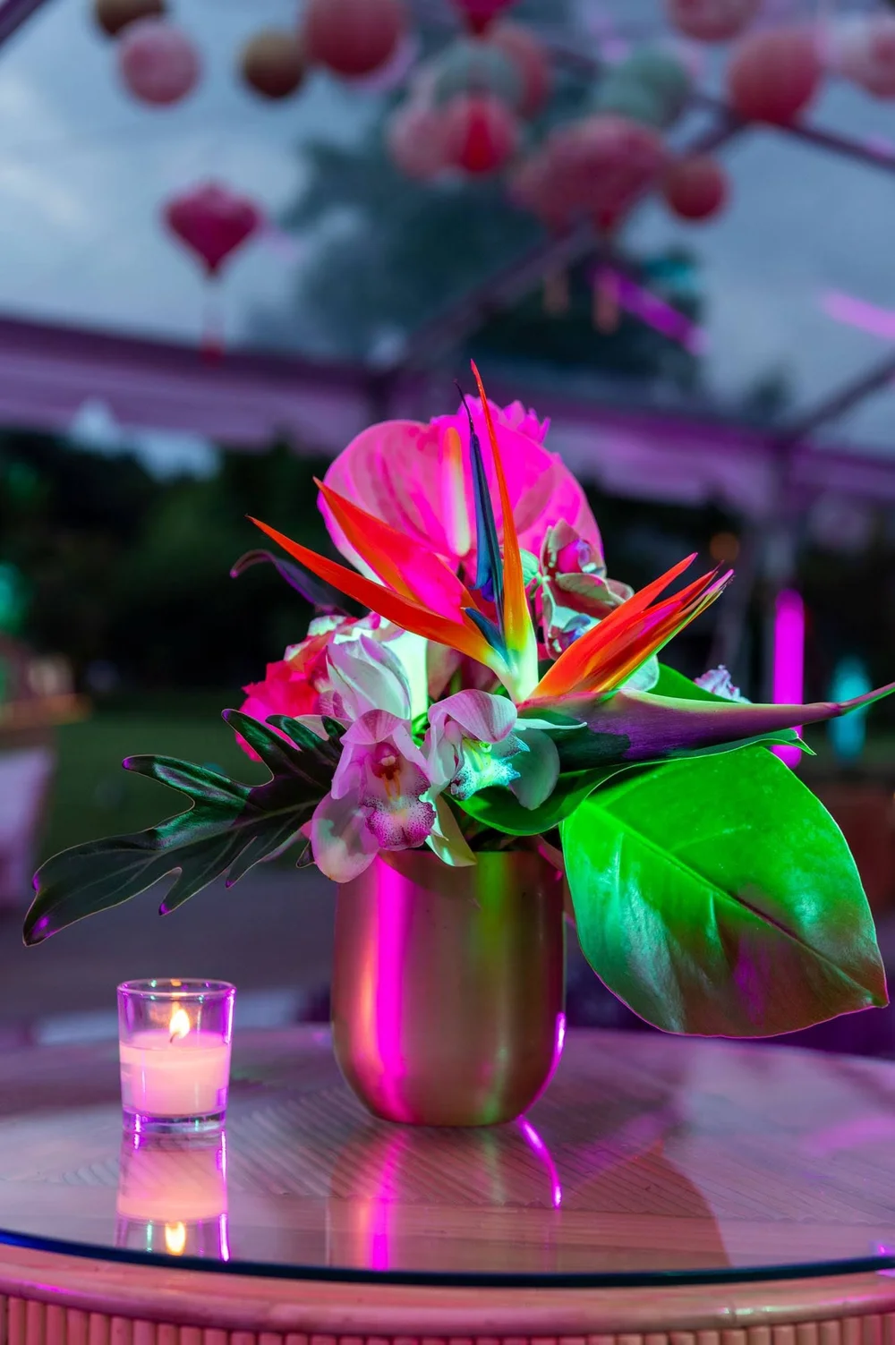 A Palm Royale party with palms, floral and fruit arrangements and a ...