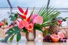 A Palm Royale party with palms, floral and fruit arrangements and a ...