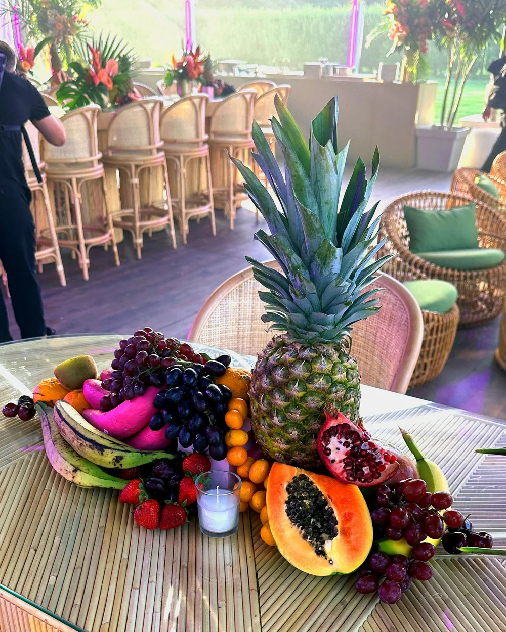 A Palm Royale party with palms, floral and fruit arrangements and a ...