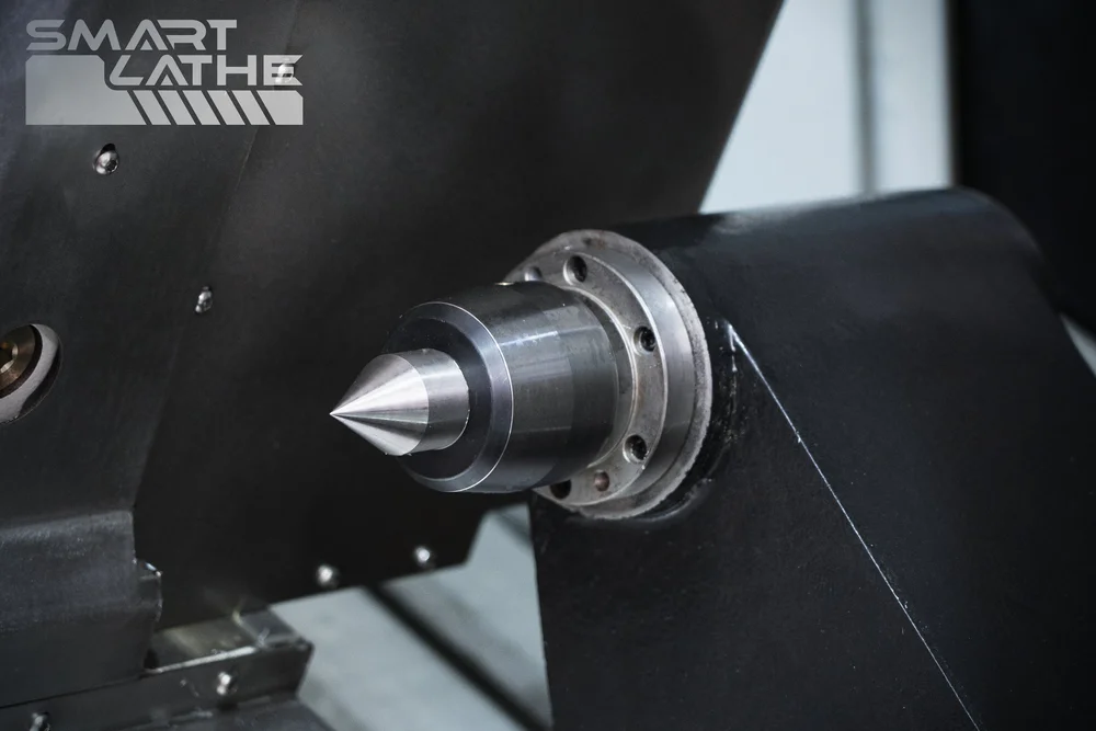 What function does the tailstock serve in the CNC machining process?
