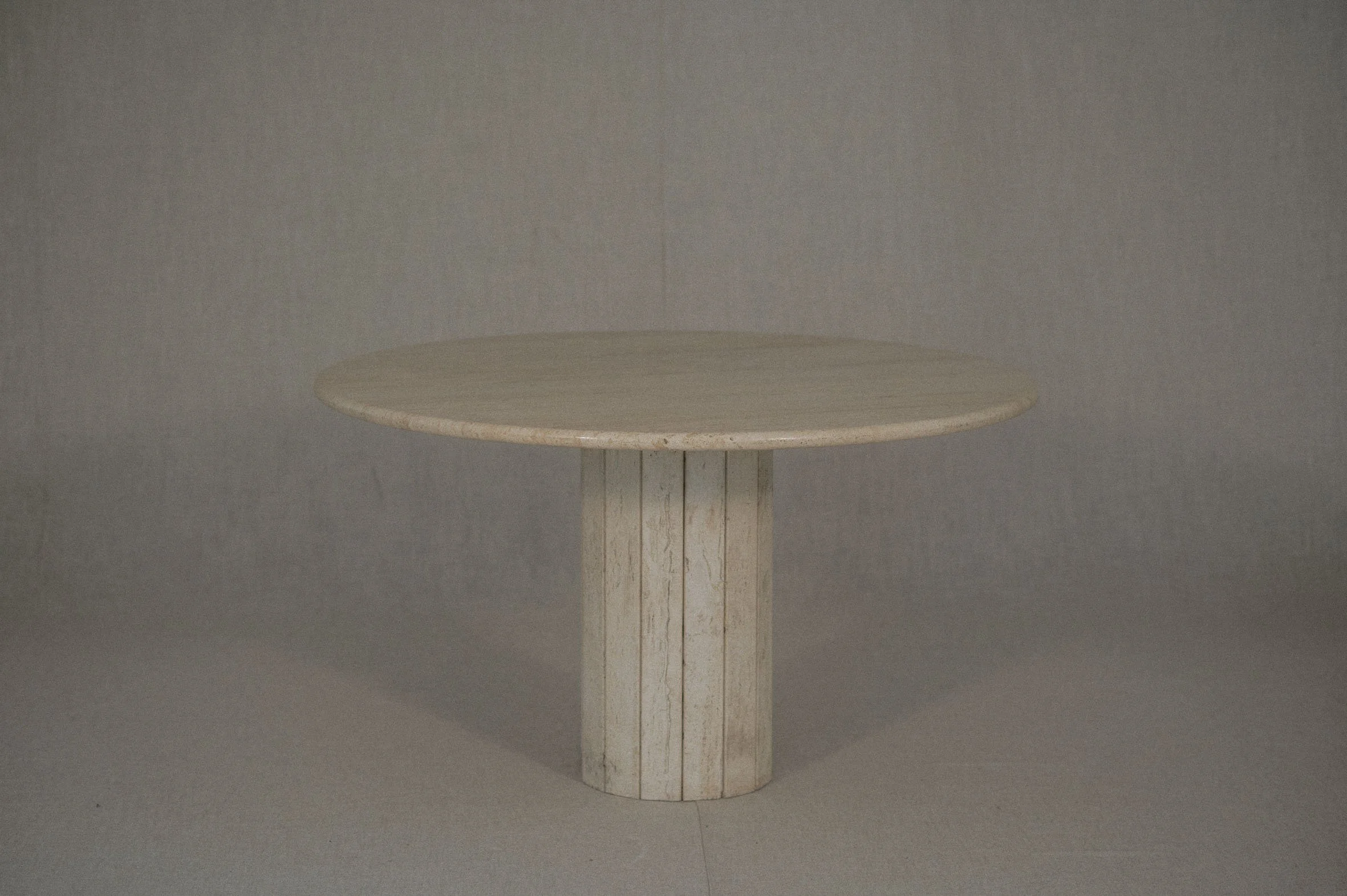 Large round travertine dining table — (RE)APPROVED