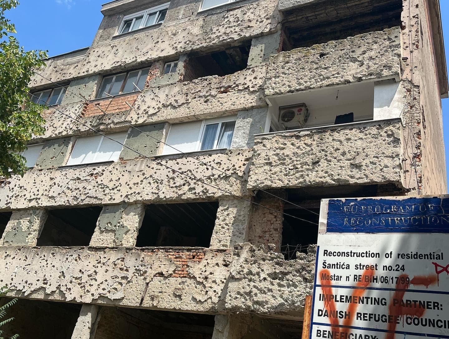 The story behind the beautiful building graffiti art in Mostar.