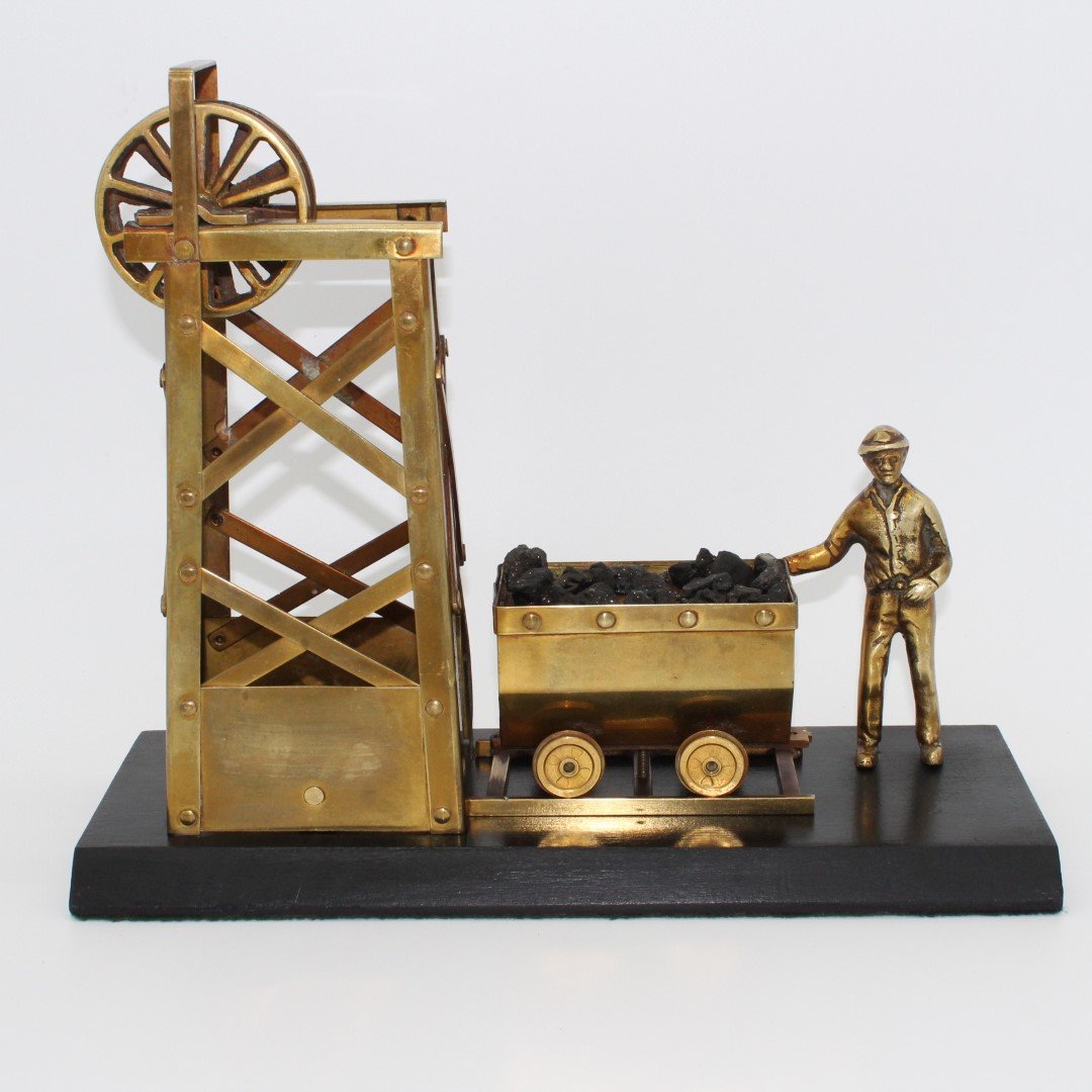 Vintage brass Welsh miner at pit head on ebonised base