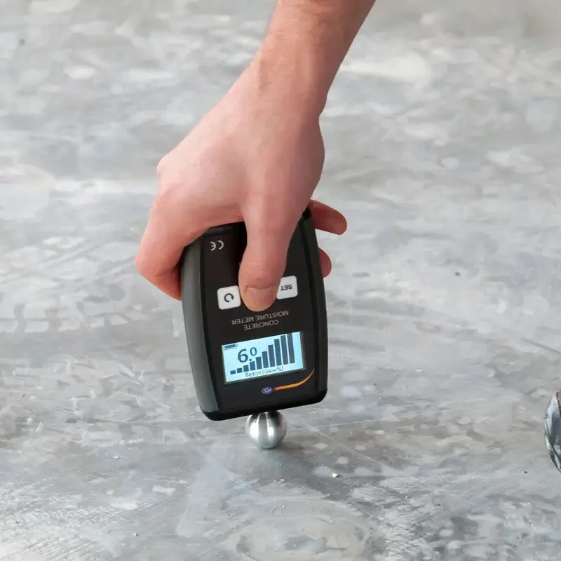 How is the moisture content of floor screed measured?