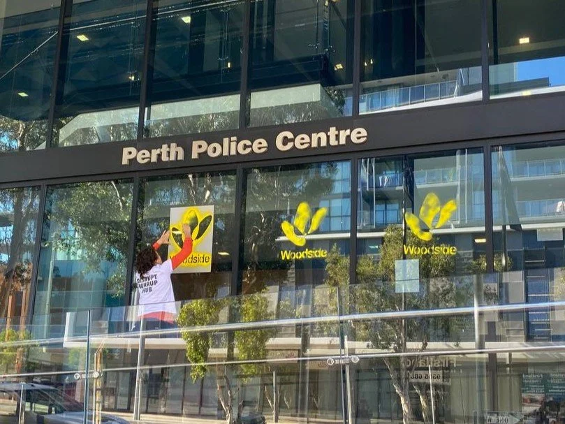Violet Coco graffitis Perth Police Centre with Woodside logo in ...
