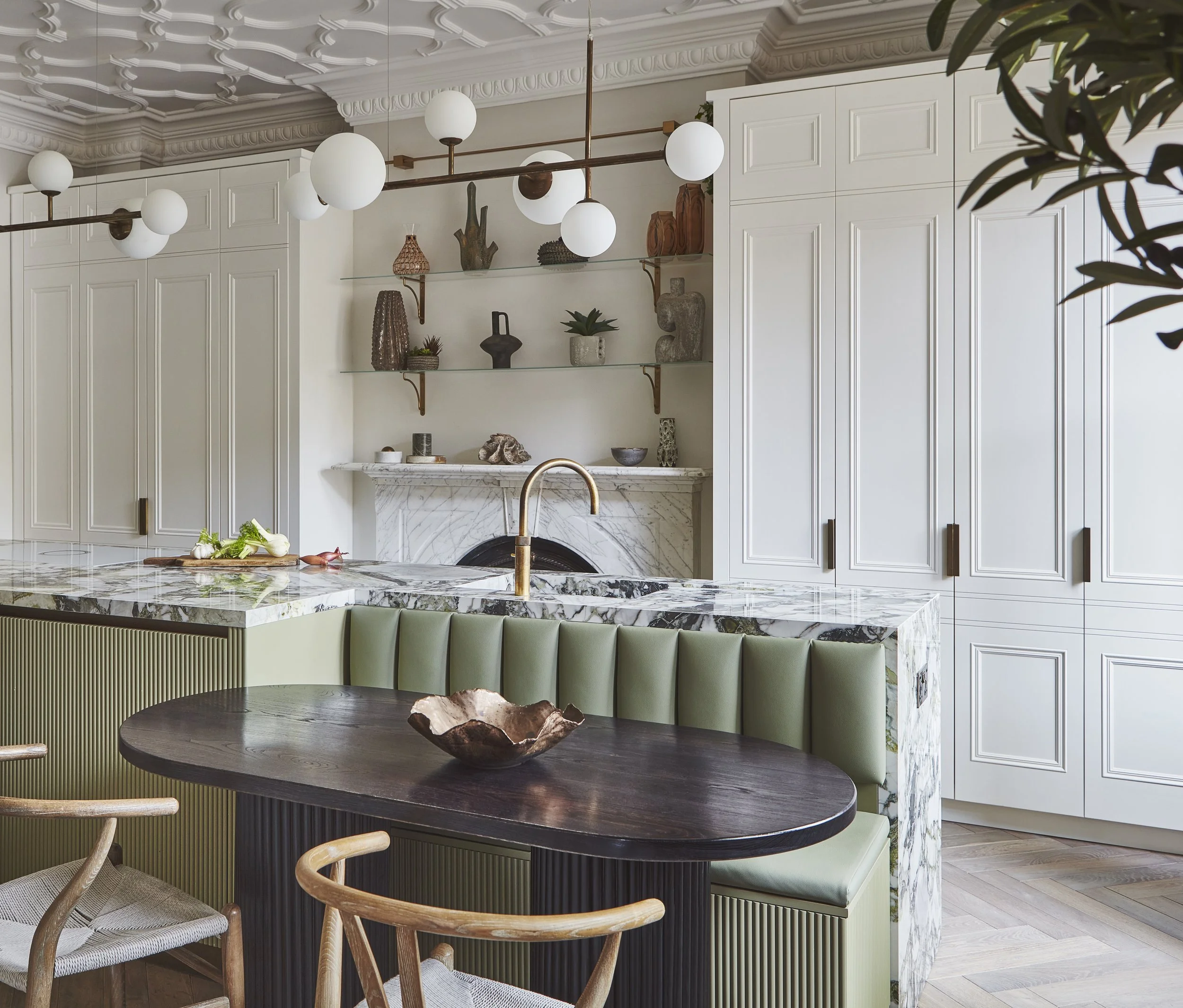 A luxury green and white timber kitchen and utility room with a ...